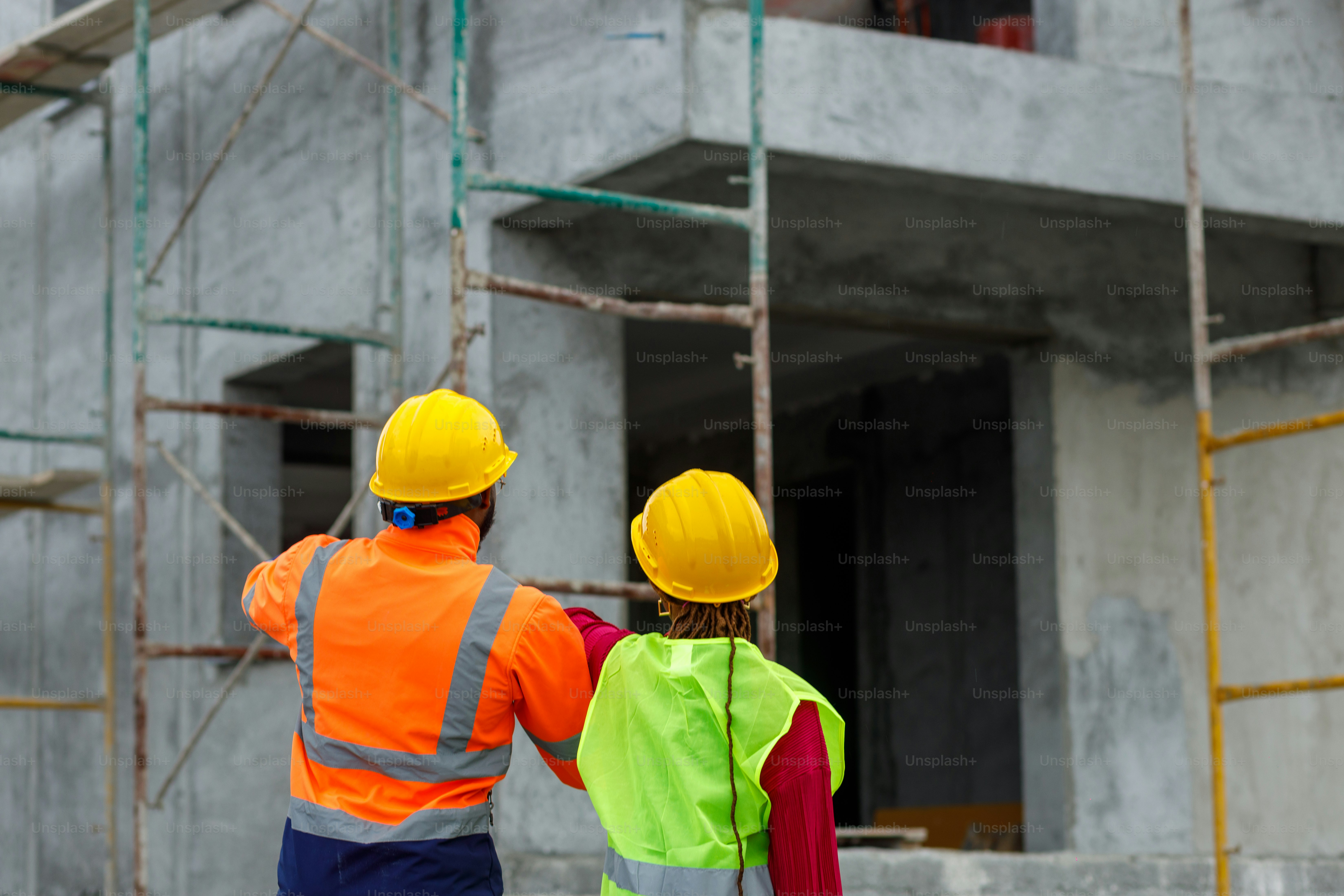 A couple of people that are standing in front of a building photo ...