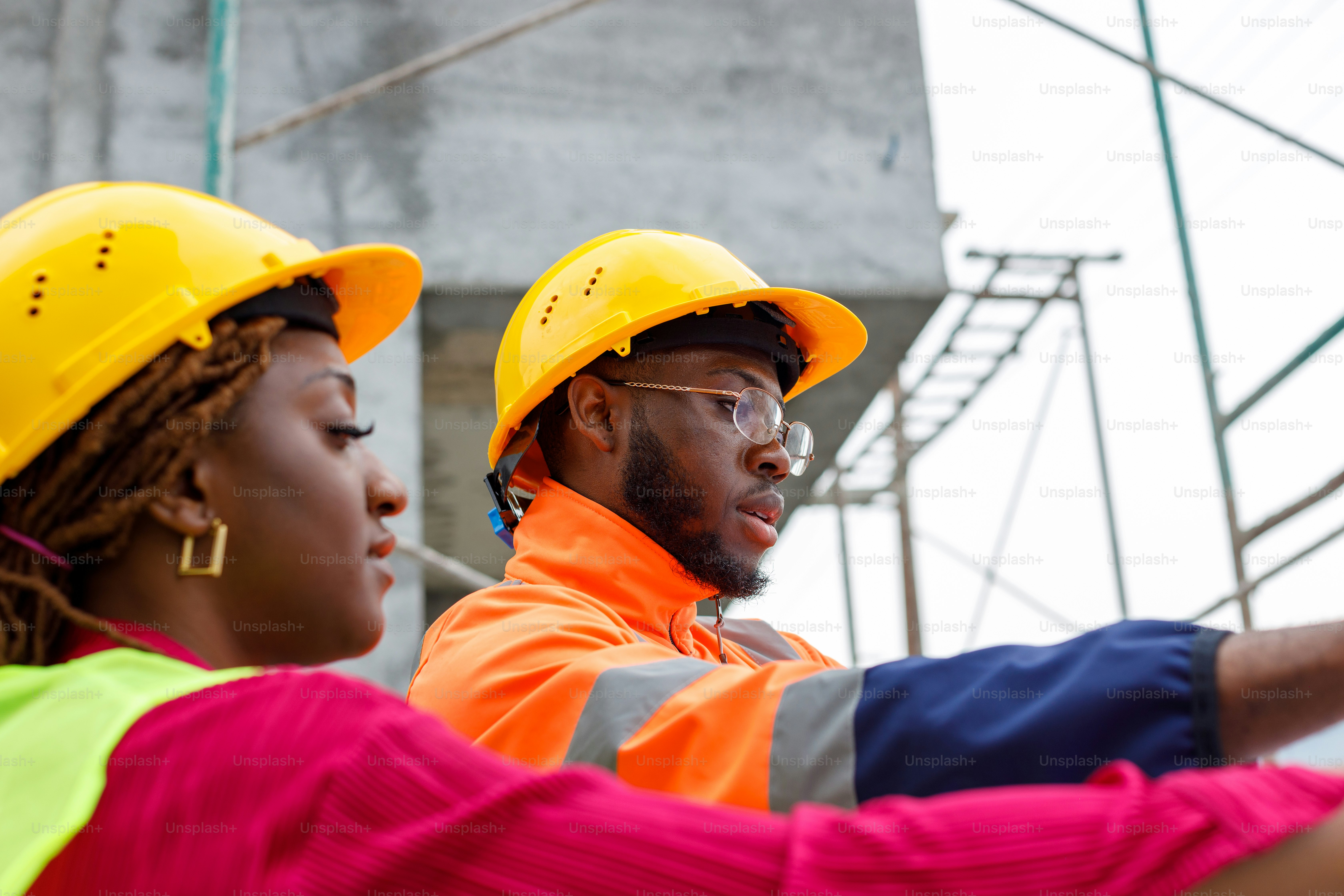 A couple of construction workers standing next to each other photo ...