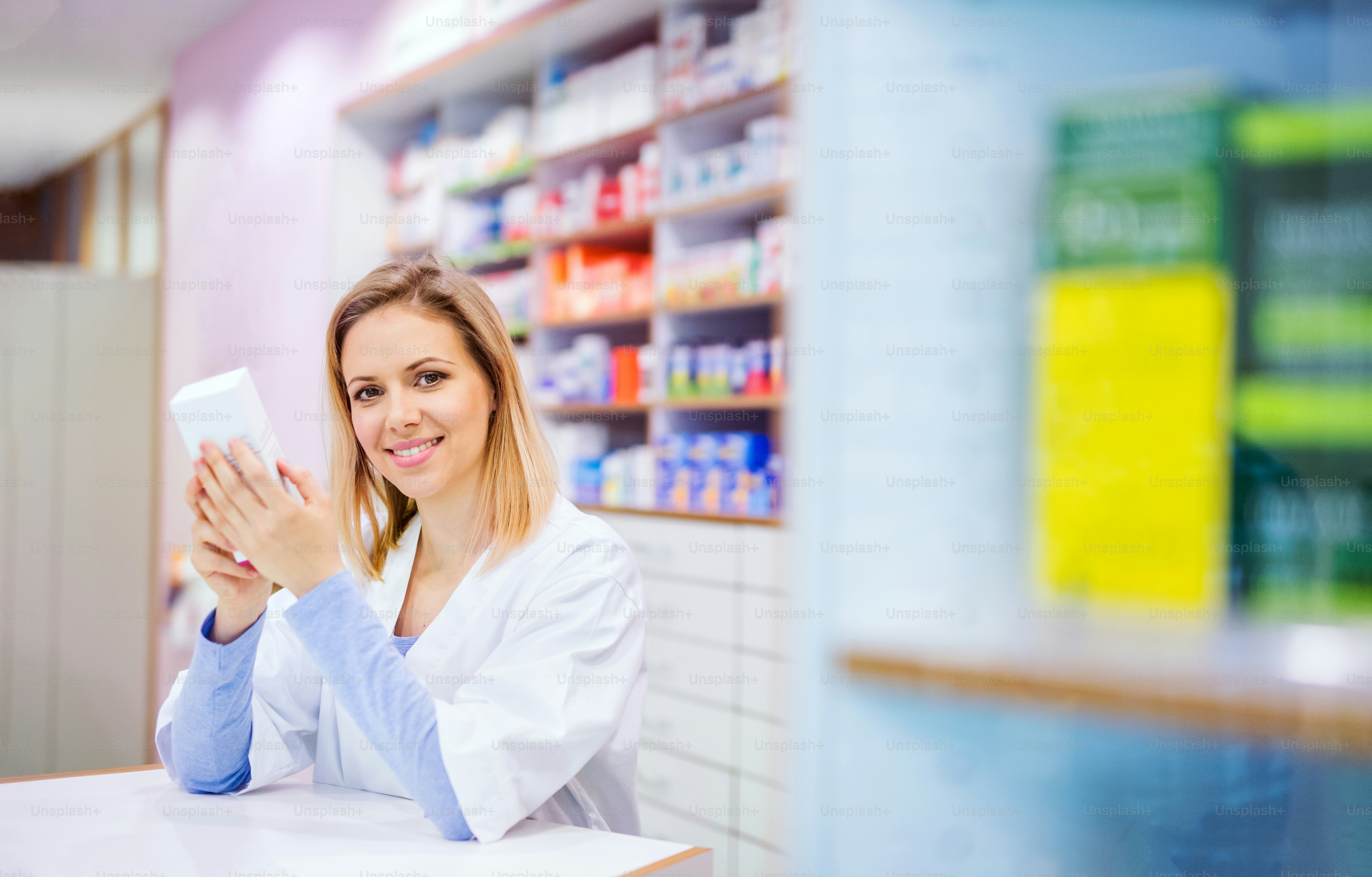 Portrait of a young beautiful friendly female pharmacist. photo ...