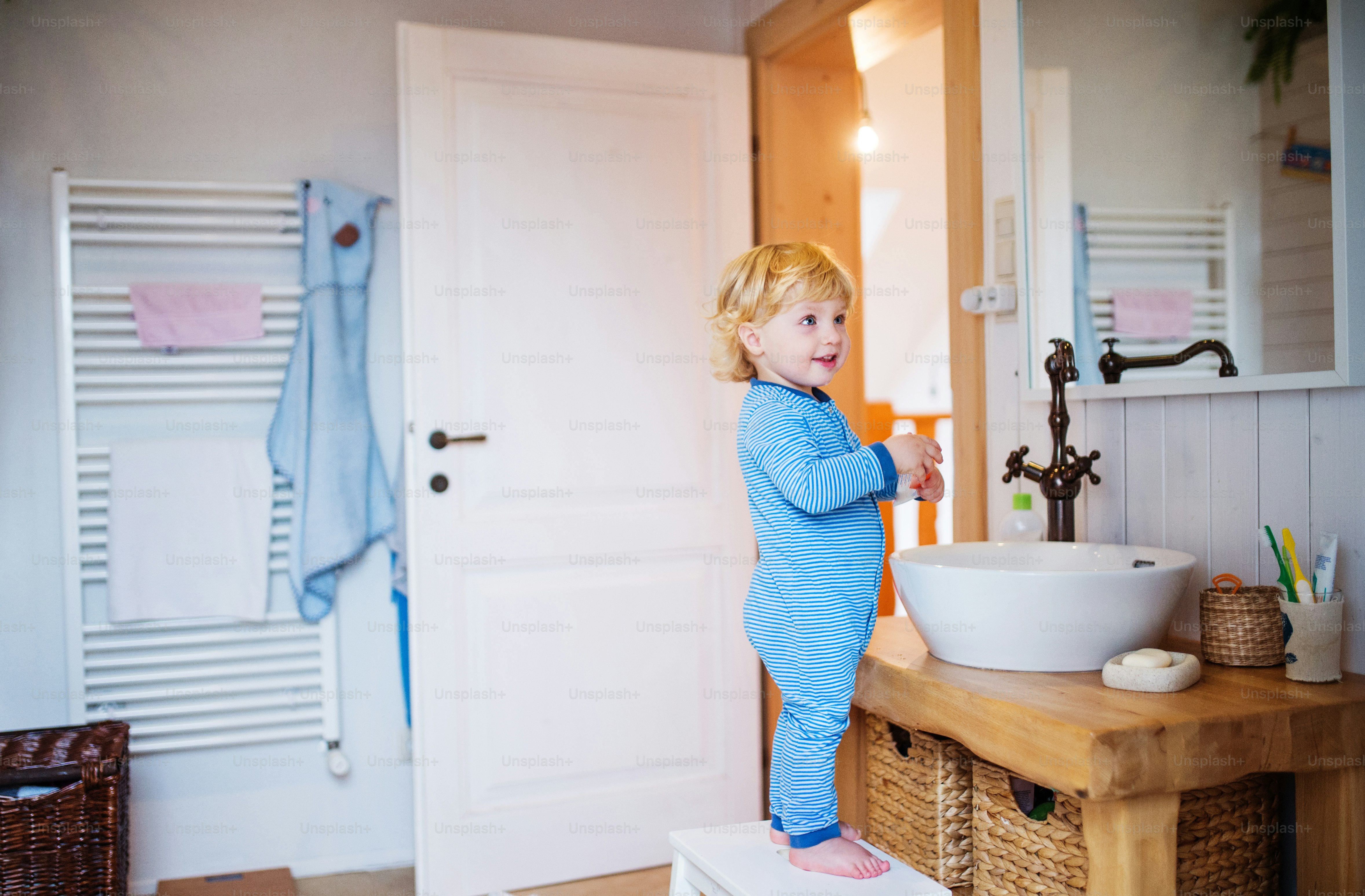 Cute toddler in the bathroom. Little boy sitting on the toilet. photo ...