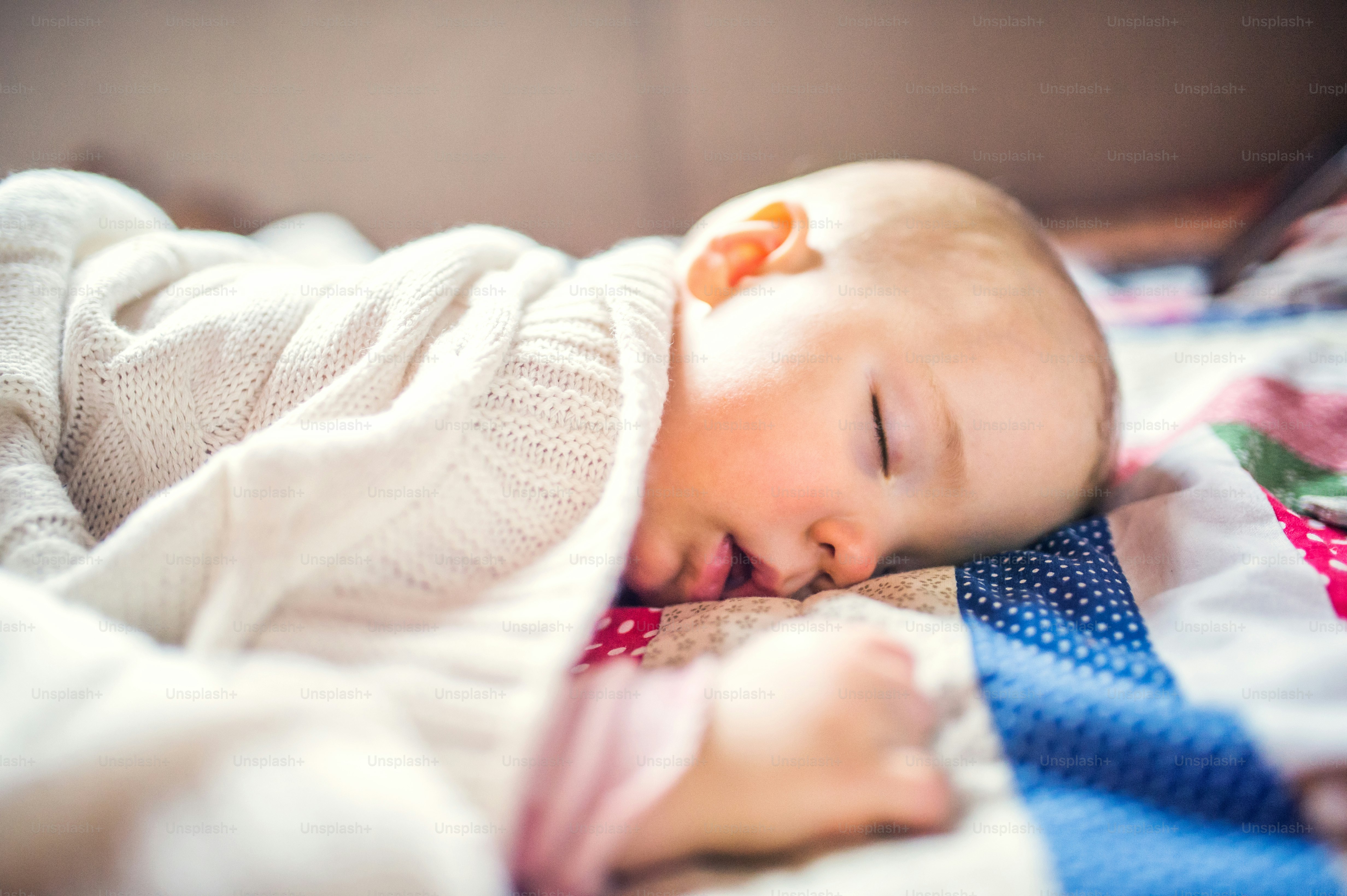 A cute toddler girl sleeping on a bed at home. photo – Bedroom Image on ...