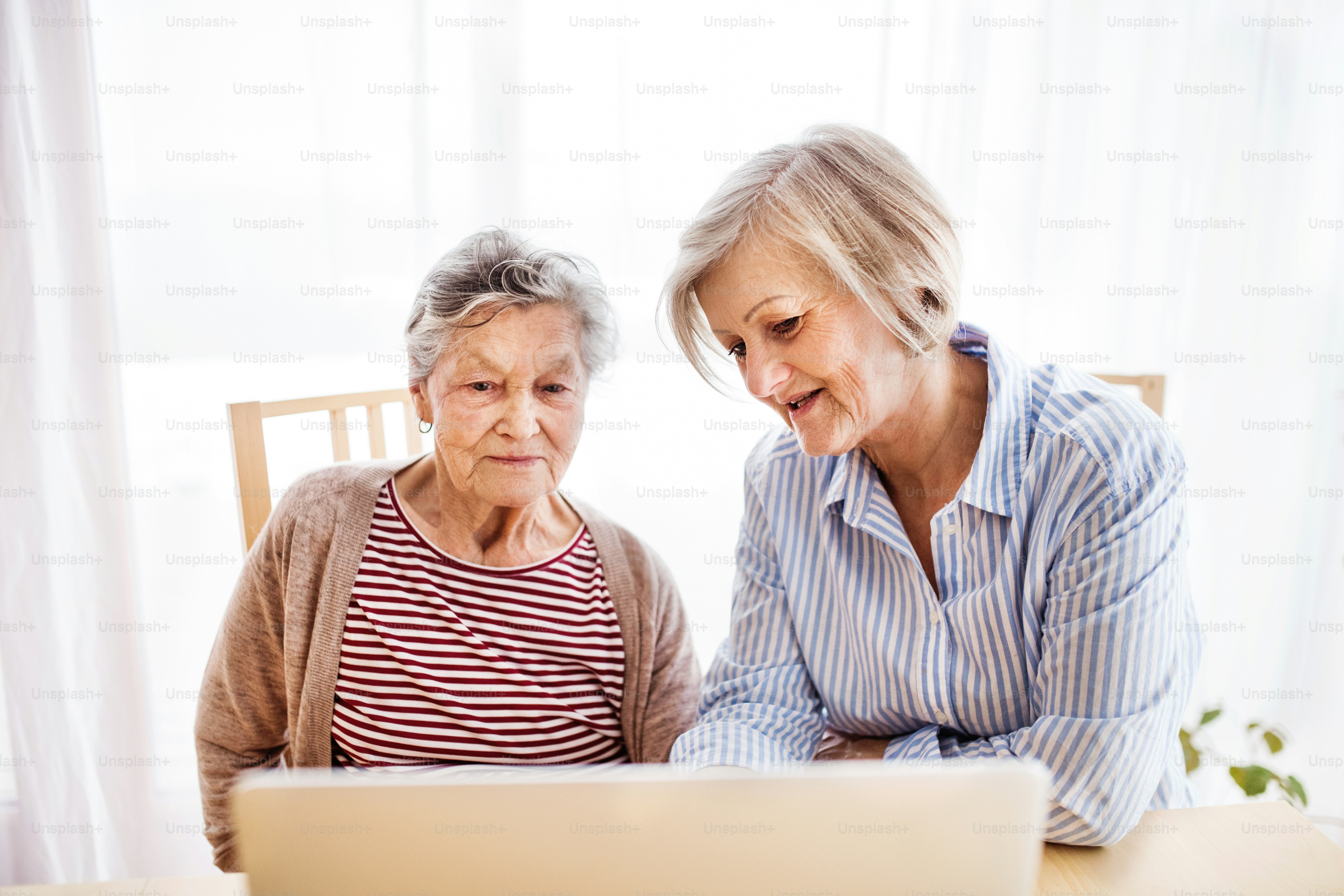 Unrecognizable senior woman with her mother with laptop at home. Family ...