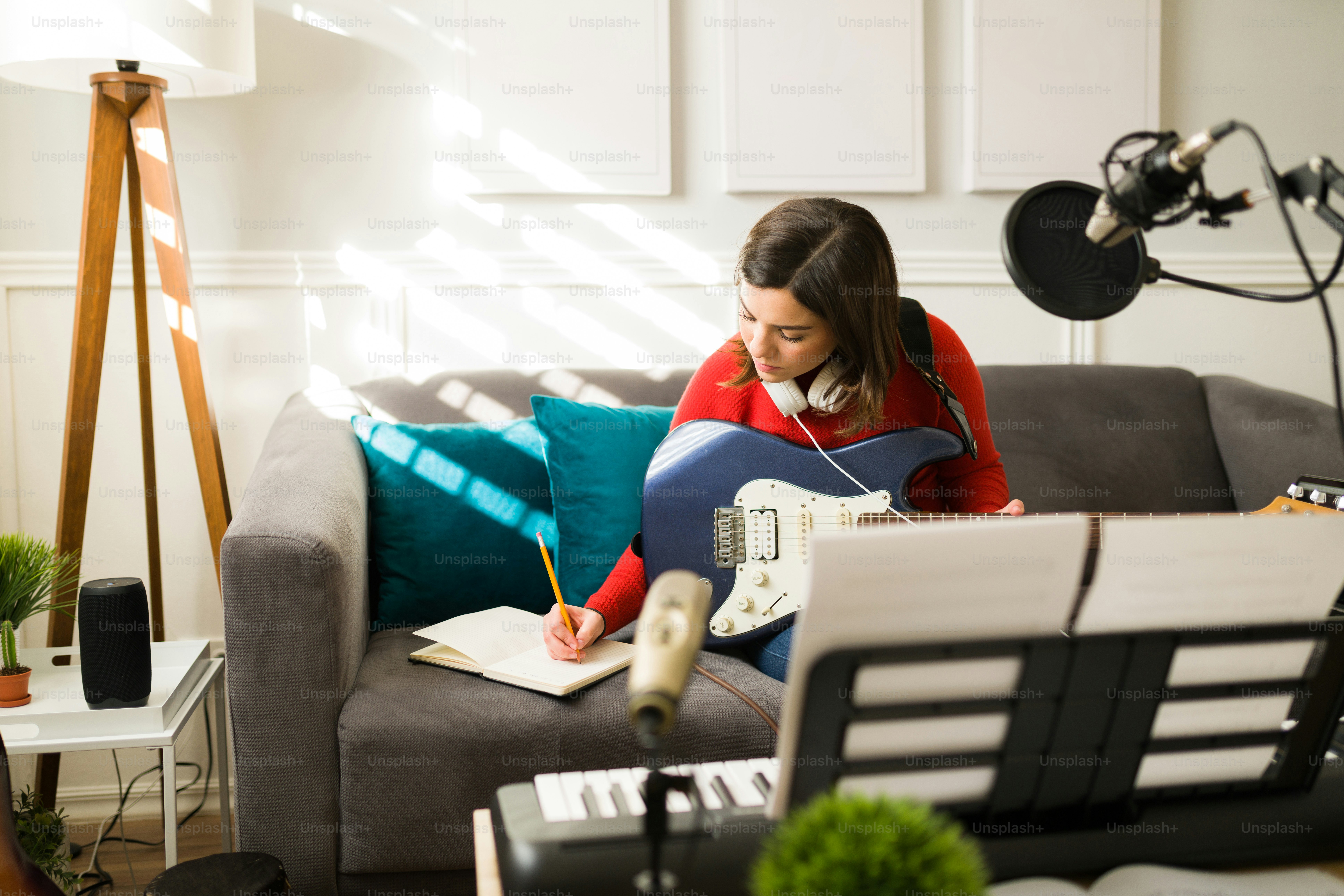 Composing new music. Talented young woman and musician writing a ...