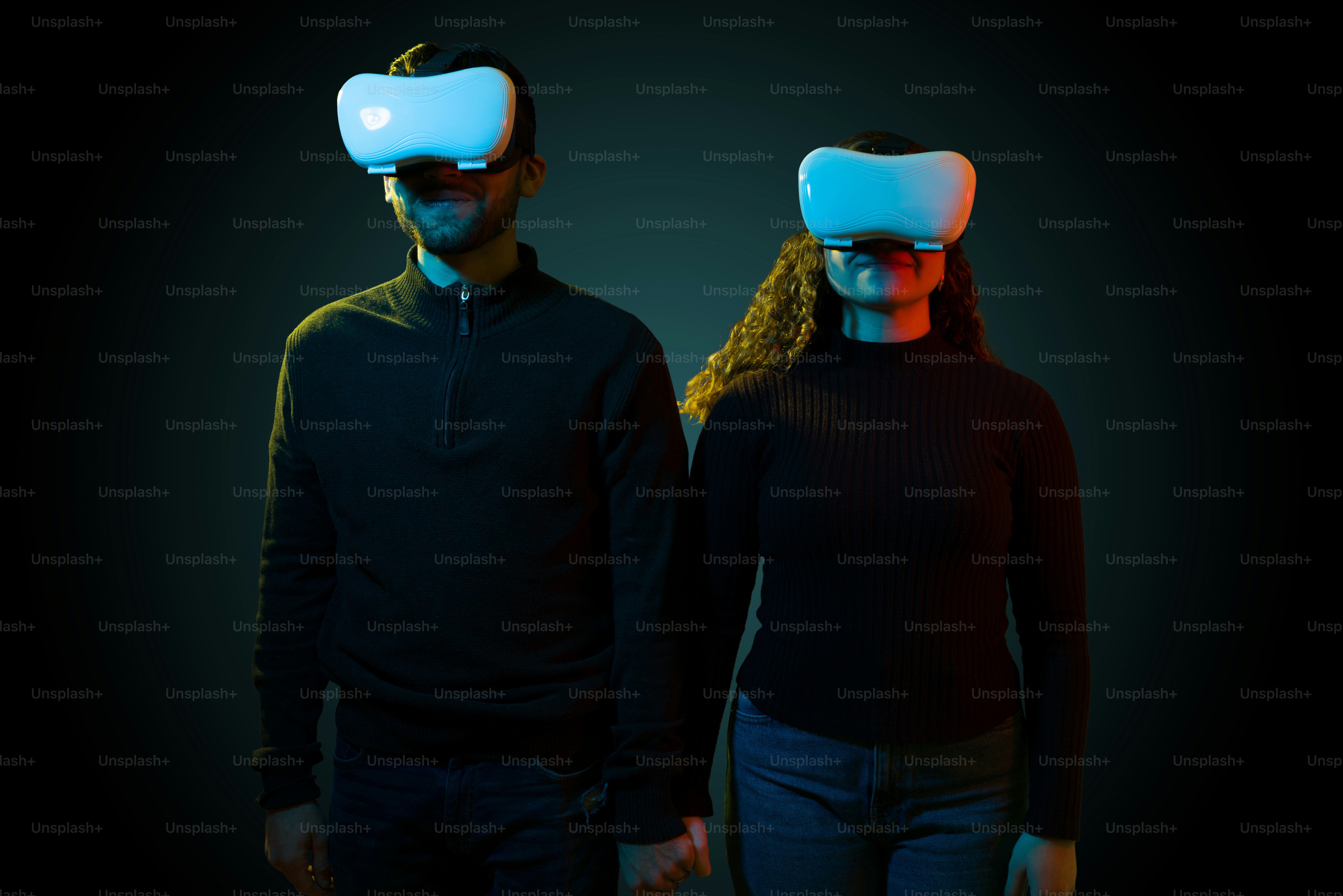 Happy couple holding hands while experiencing the virtual reality ...