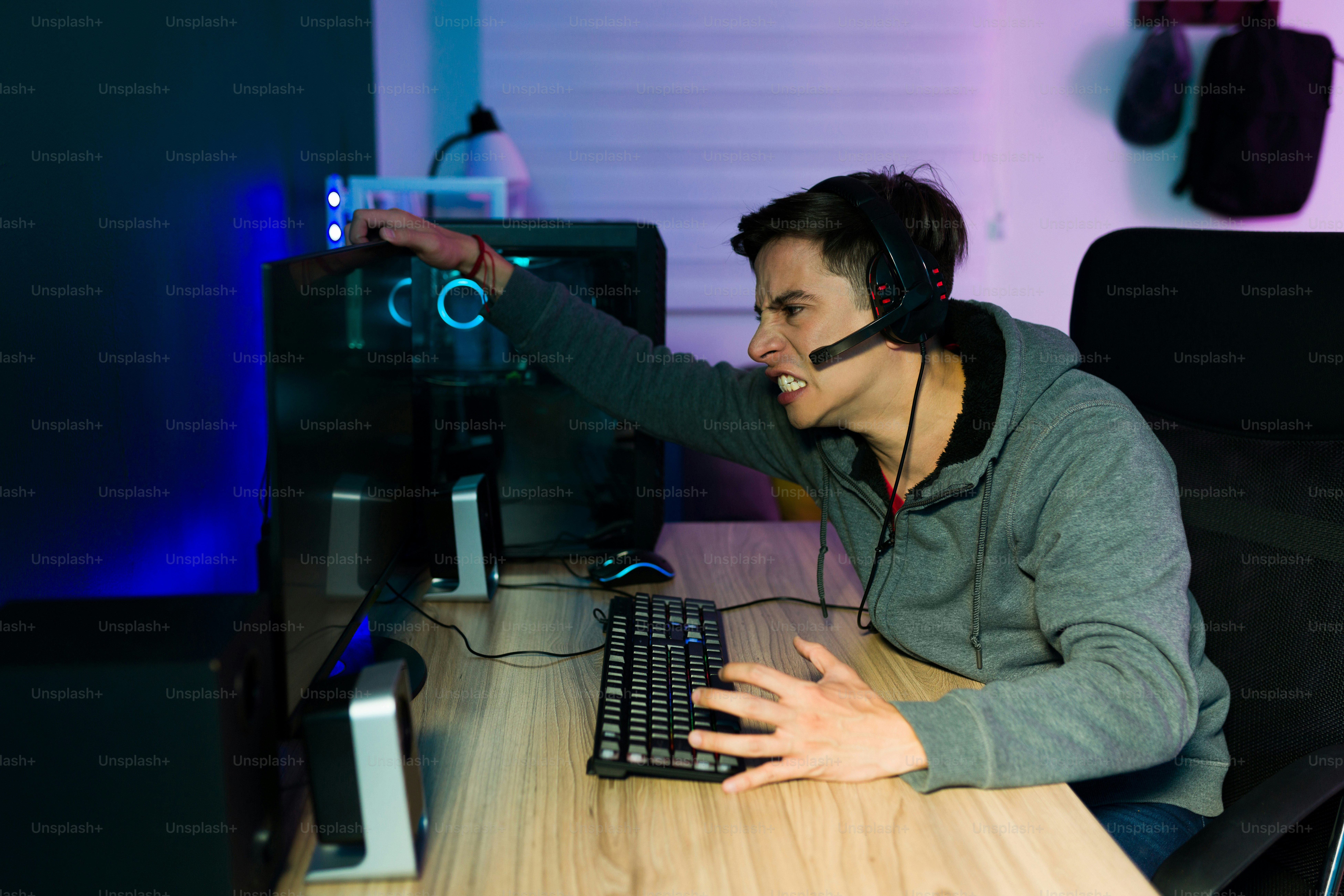 Feeling very furious. Angry male gamer annoyed after losing a video ...