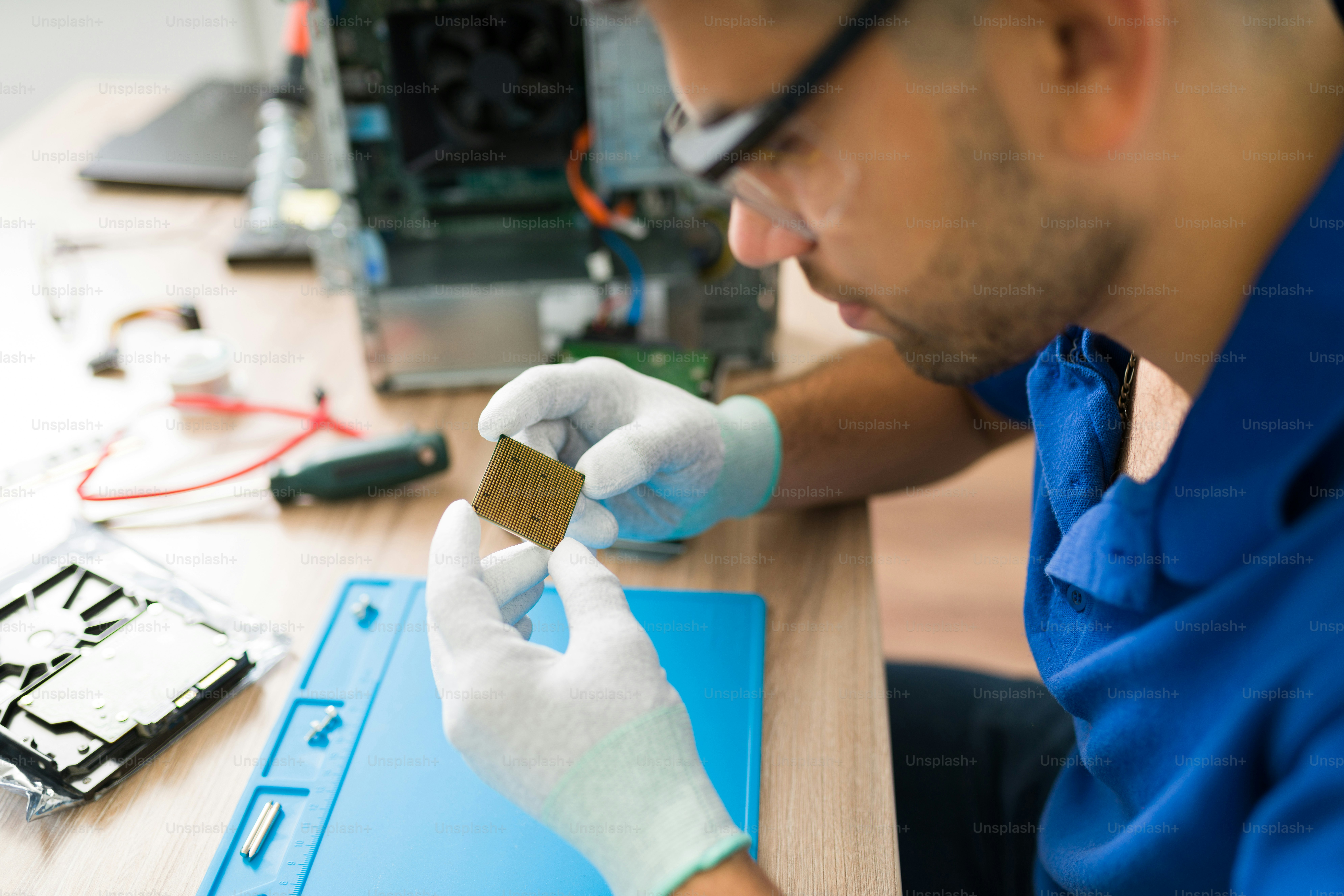 Close up of the technician's hands soldering tin to solder and repair a ...