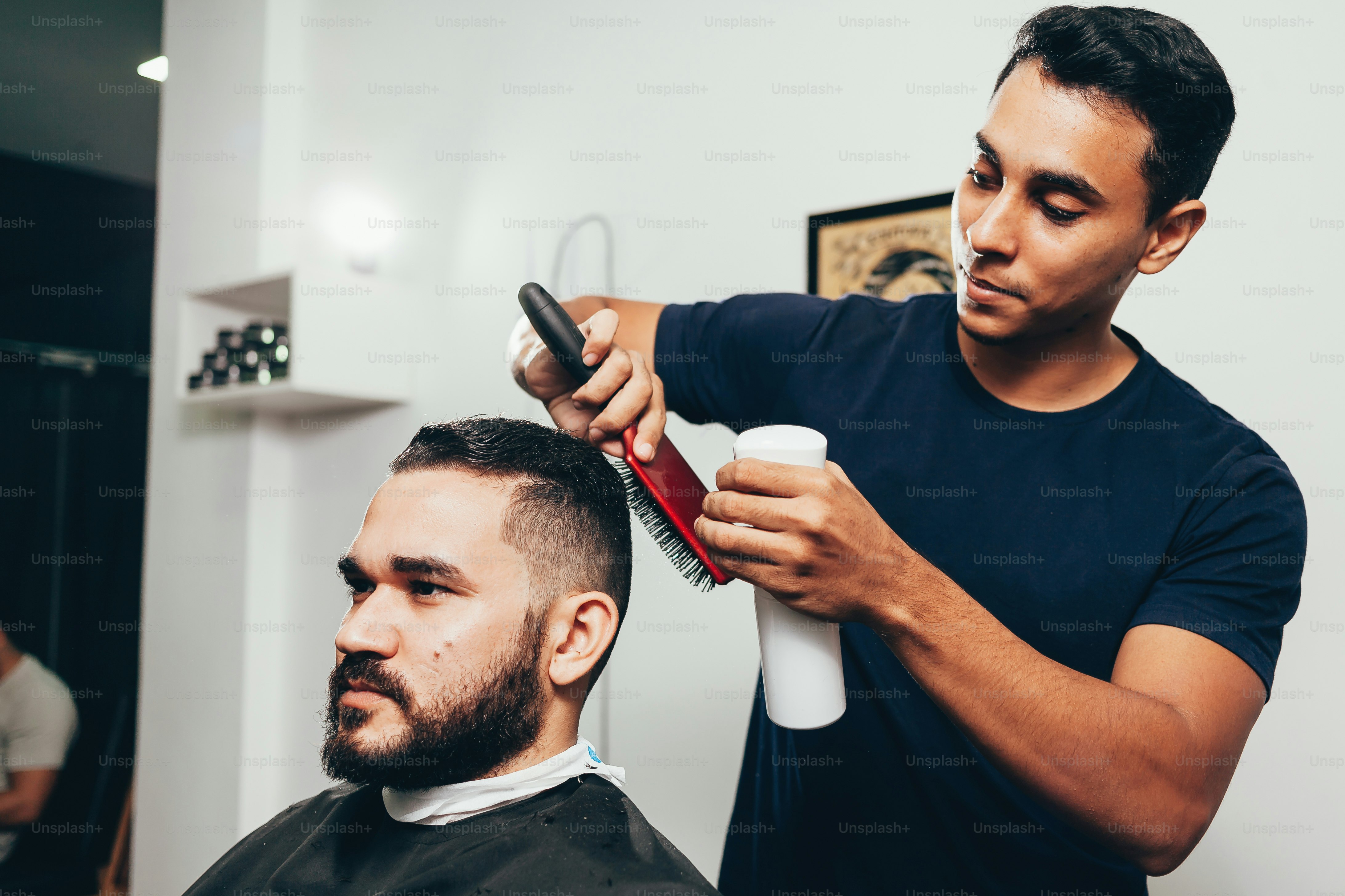 Client during beard and hair grooming in barber shop photo ...