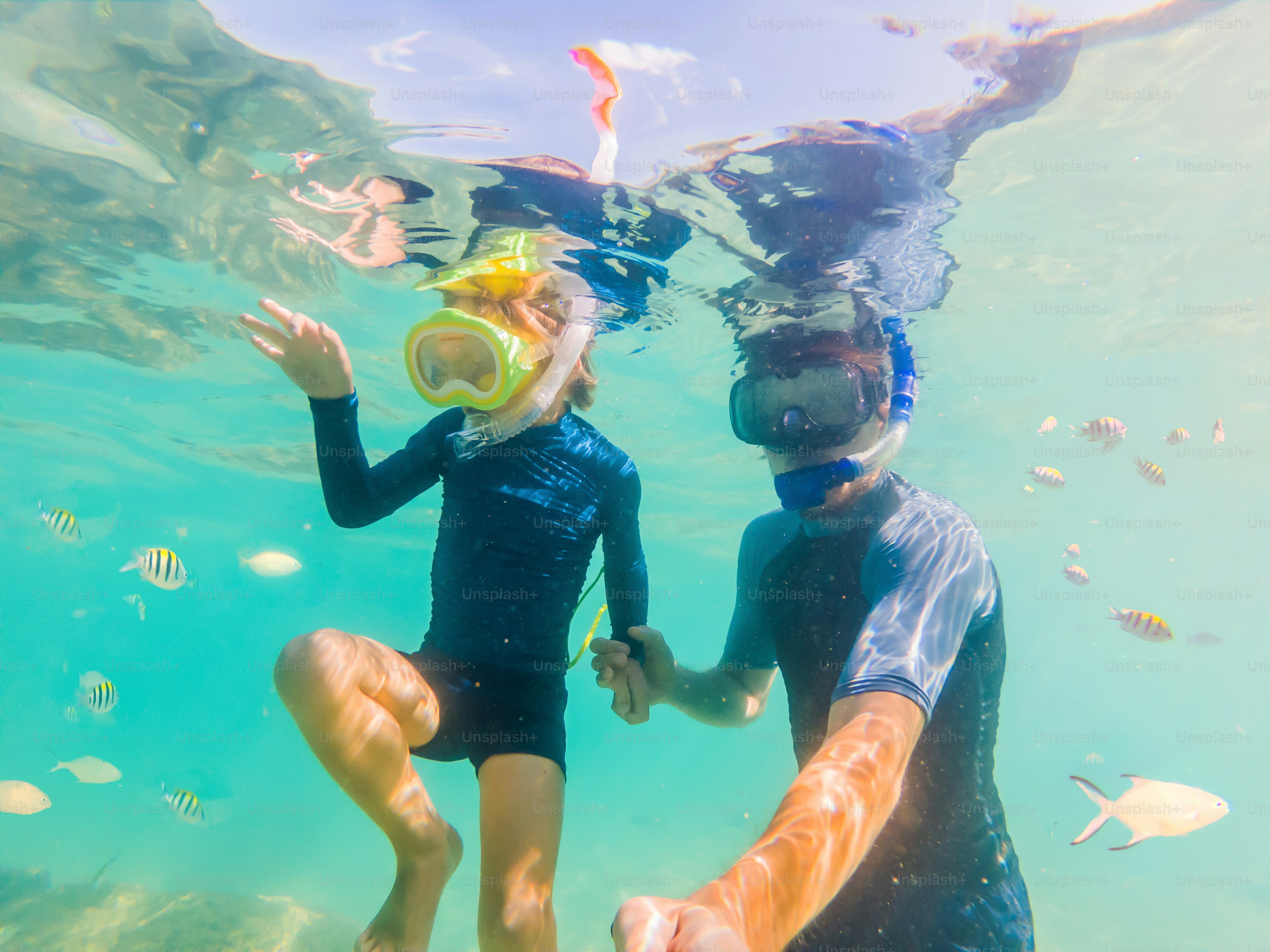 Underwater portrait of father and son snorkeling together. photo ...