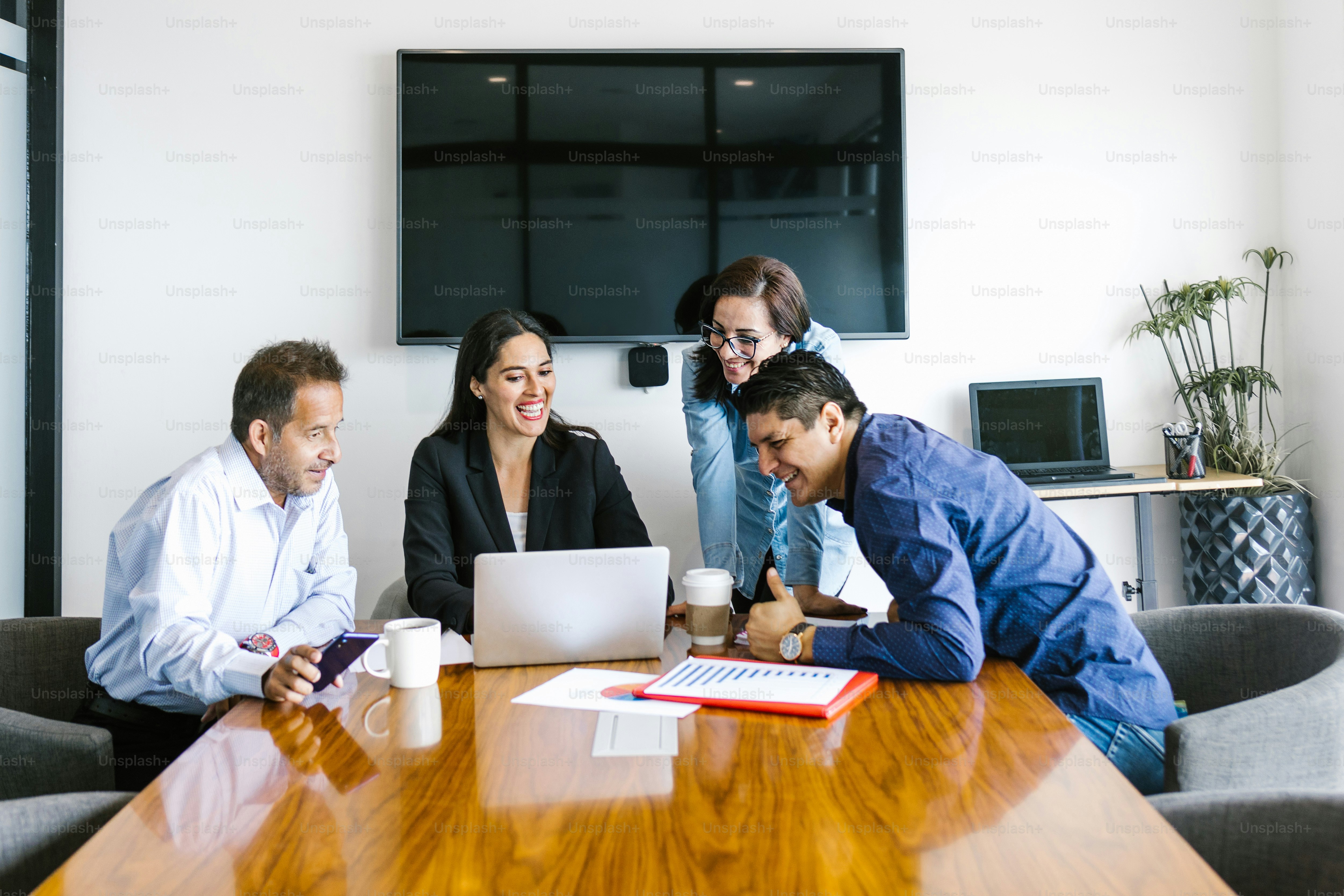 Group of hispanic people doing teamwork in office using digital devices in Latin America photo ...