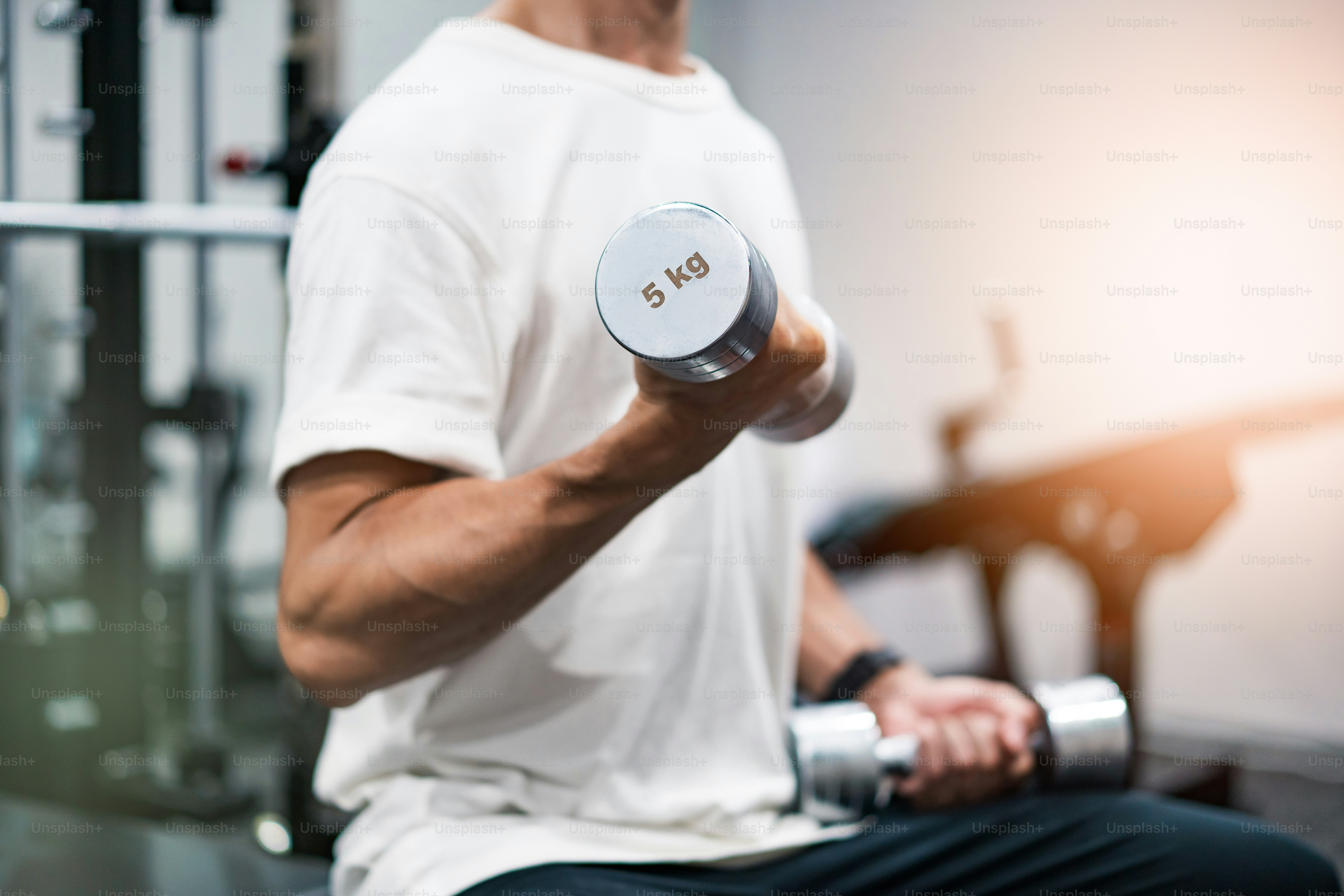 MIddle-aged man doing muscle training with dumbbells photo – Gym Image ...