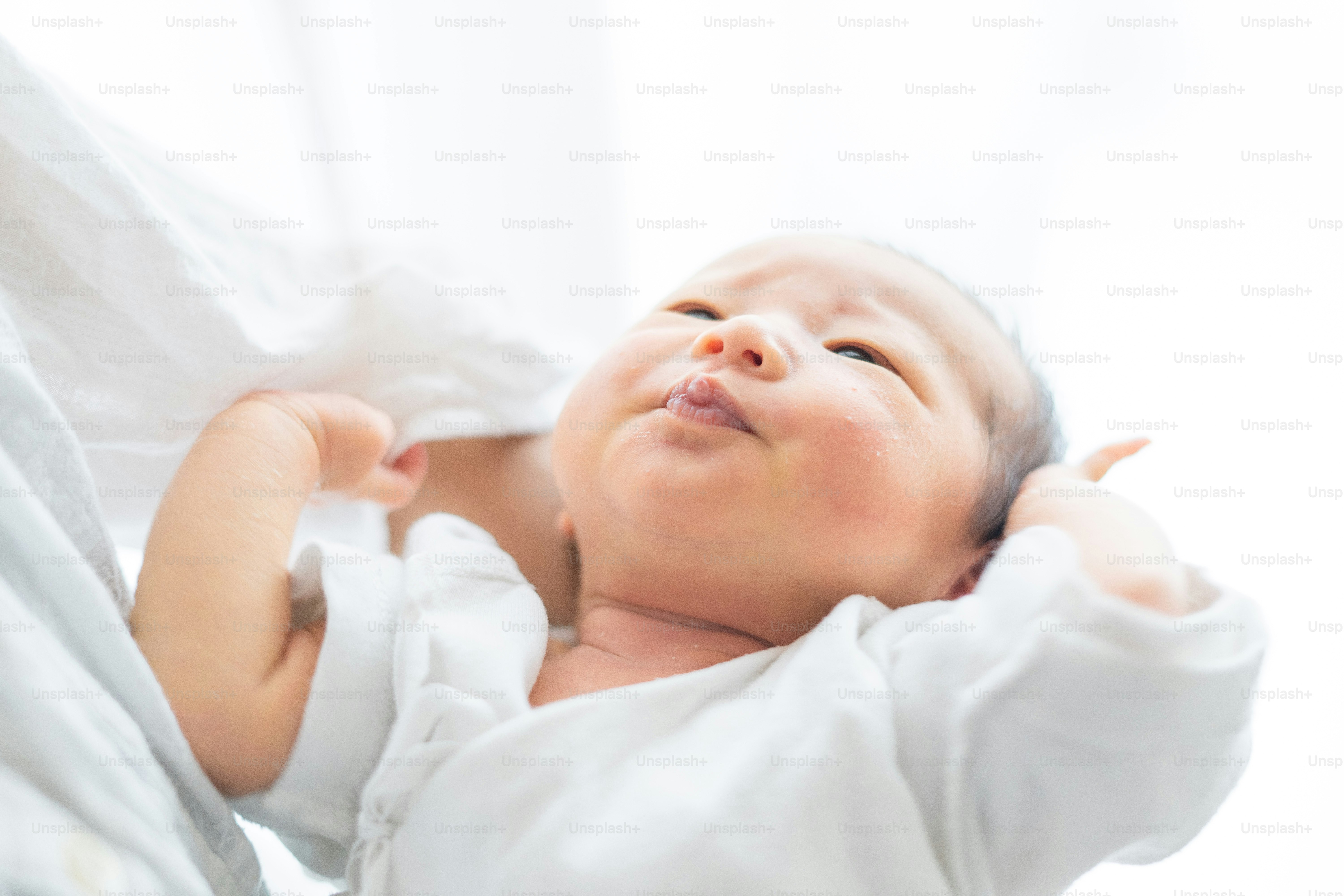 A mother carrying an Asian (Japanese) newborn baby (0 year old 0 month ...