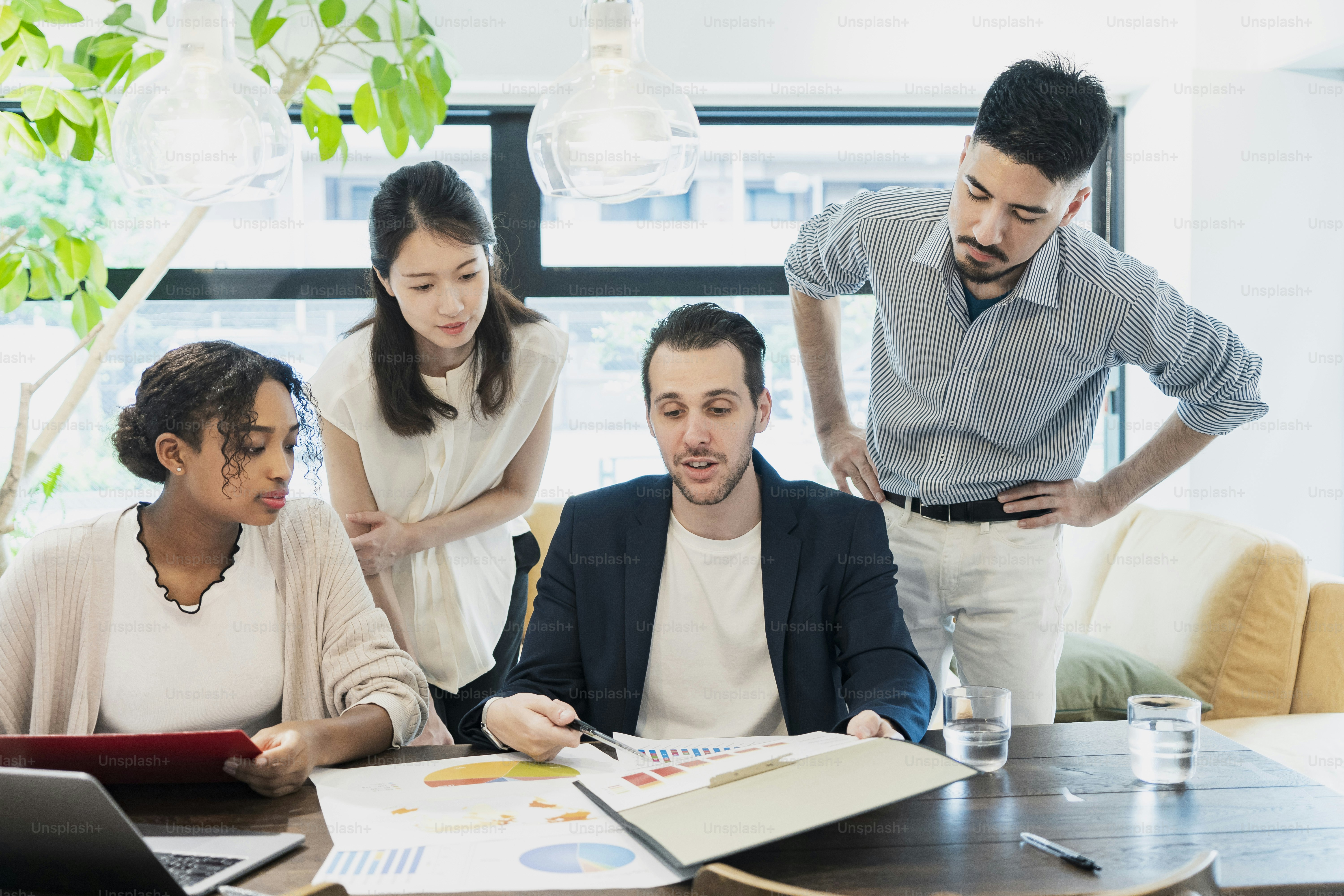 Businessmen of various races meeting in a casual office space photo ...