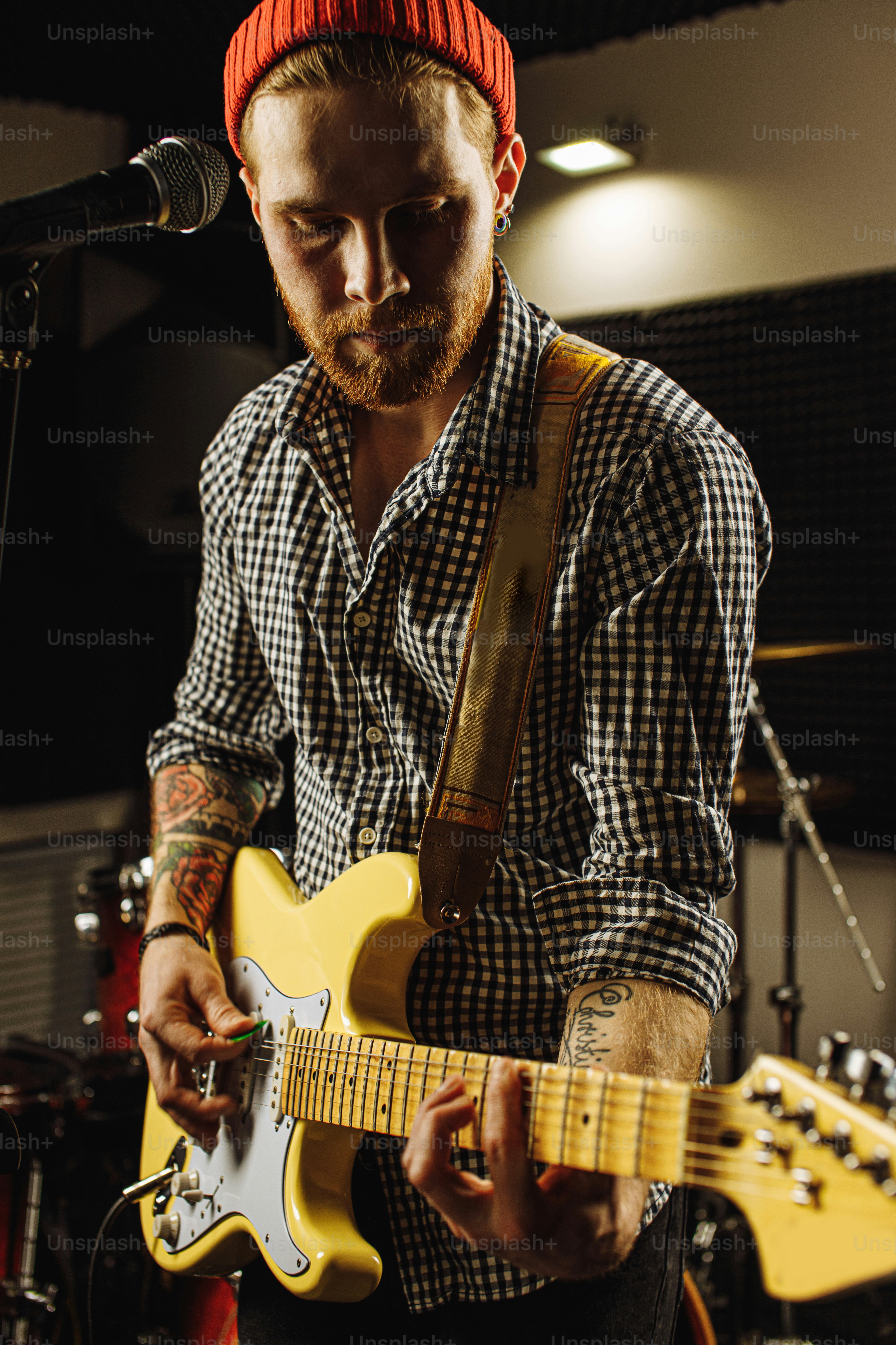 Handsome caucasian guy enjoy playing electric guitar in recording ...