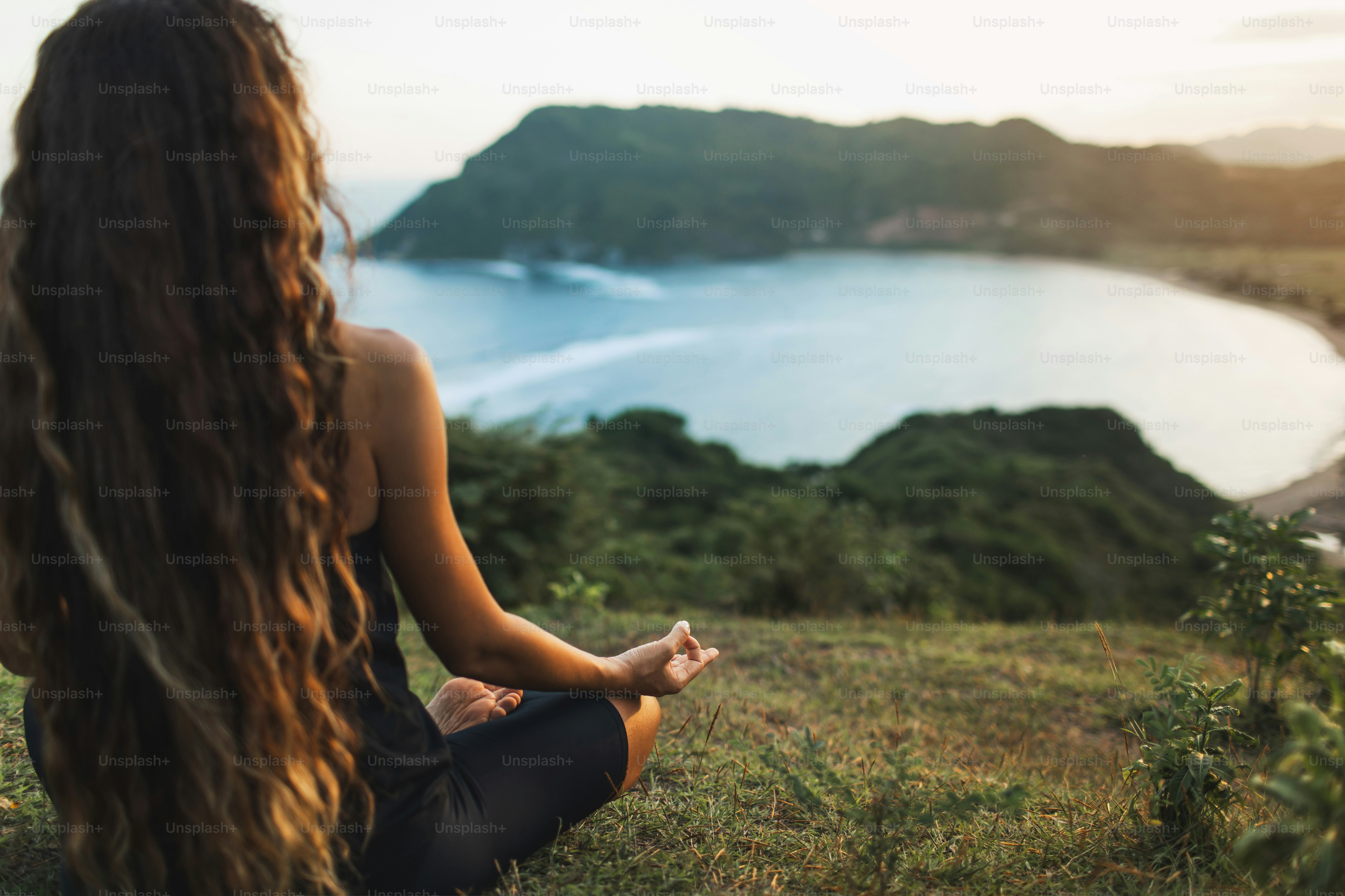 Woman meditating alone on infinity poolside with beautiful ocean and ...