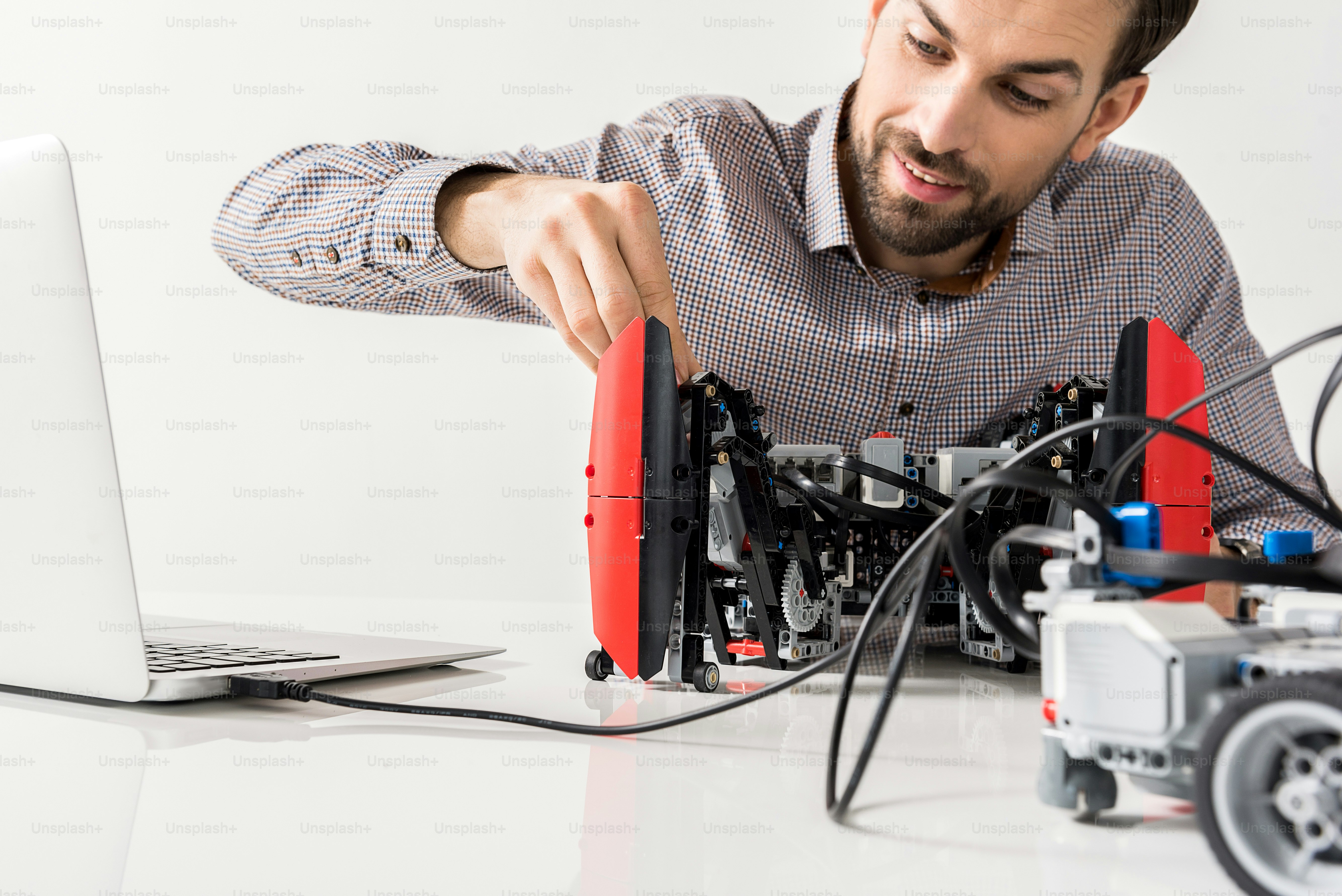 All goes fine. Energetic young bearded inventor is constructing small ...