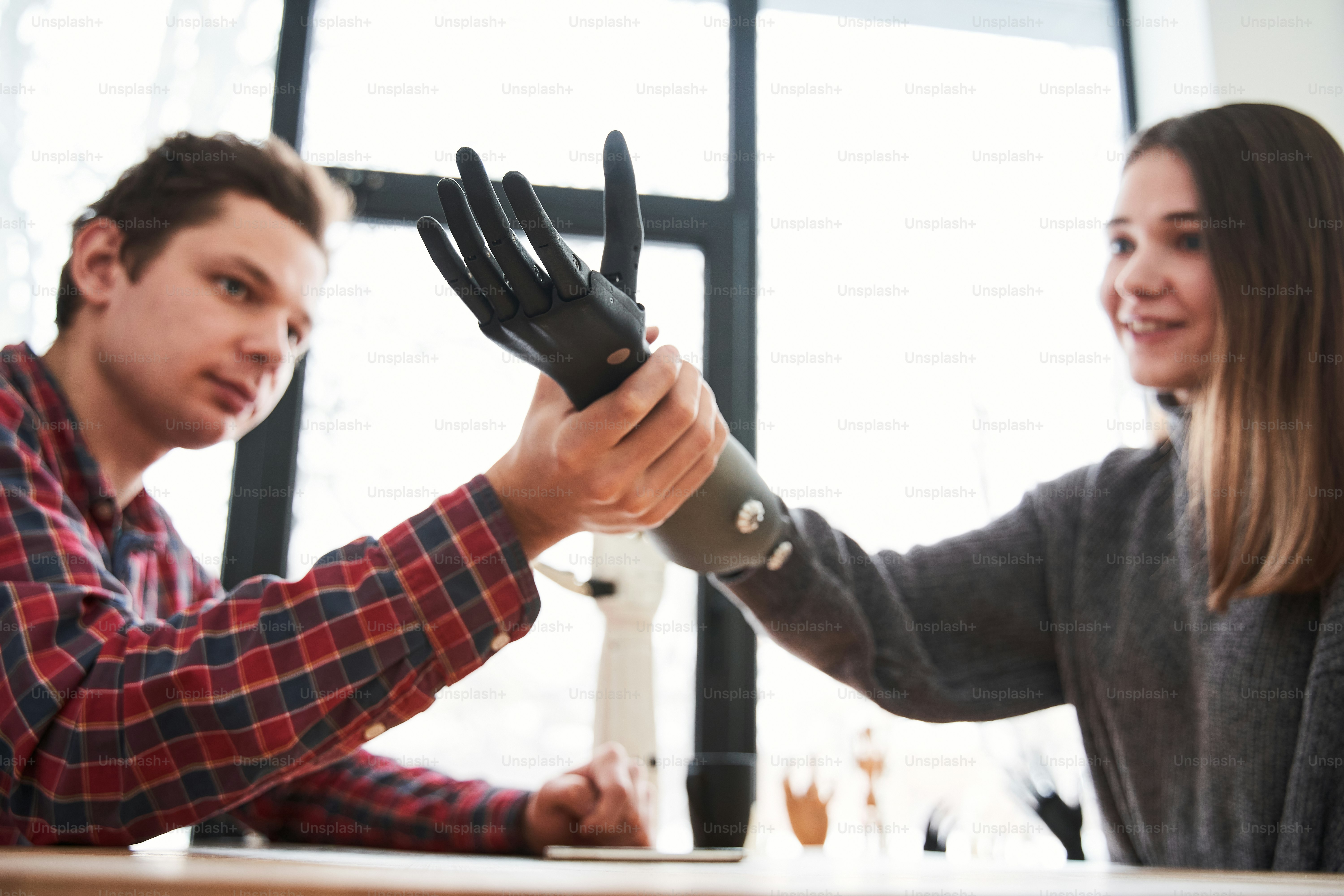 Trying on a prosthesis. Close up portrait of the male engineer putting ...