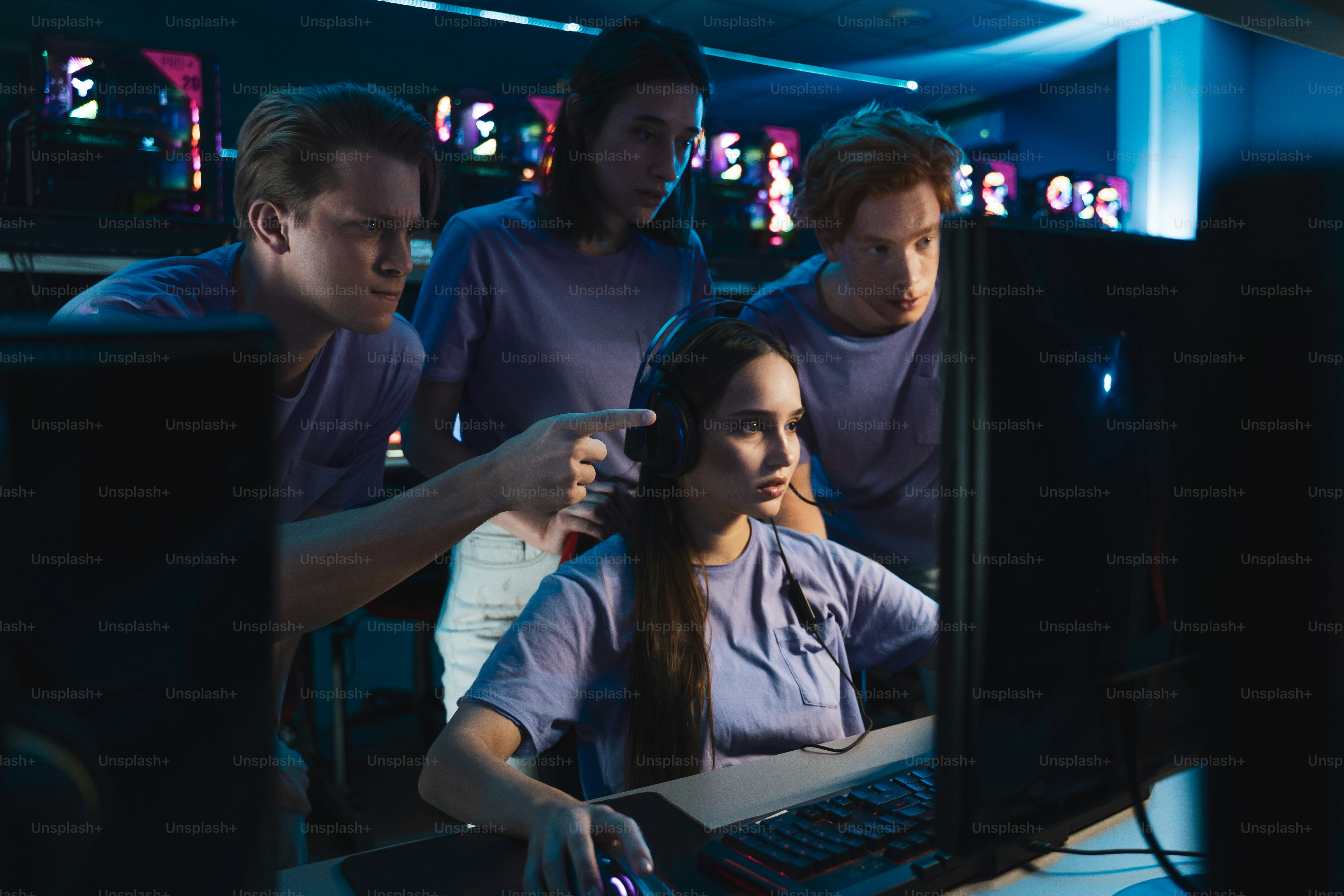 Two guys and girl at the computer club giving support to their female ...