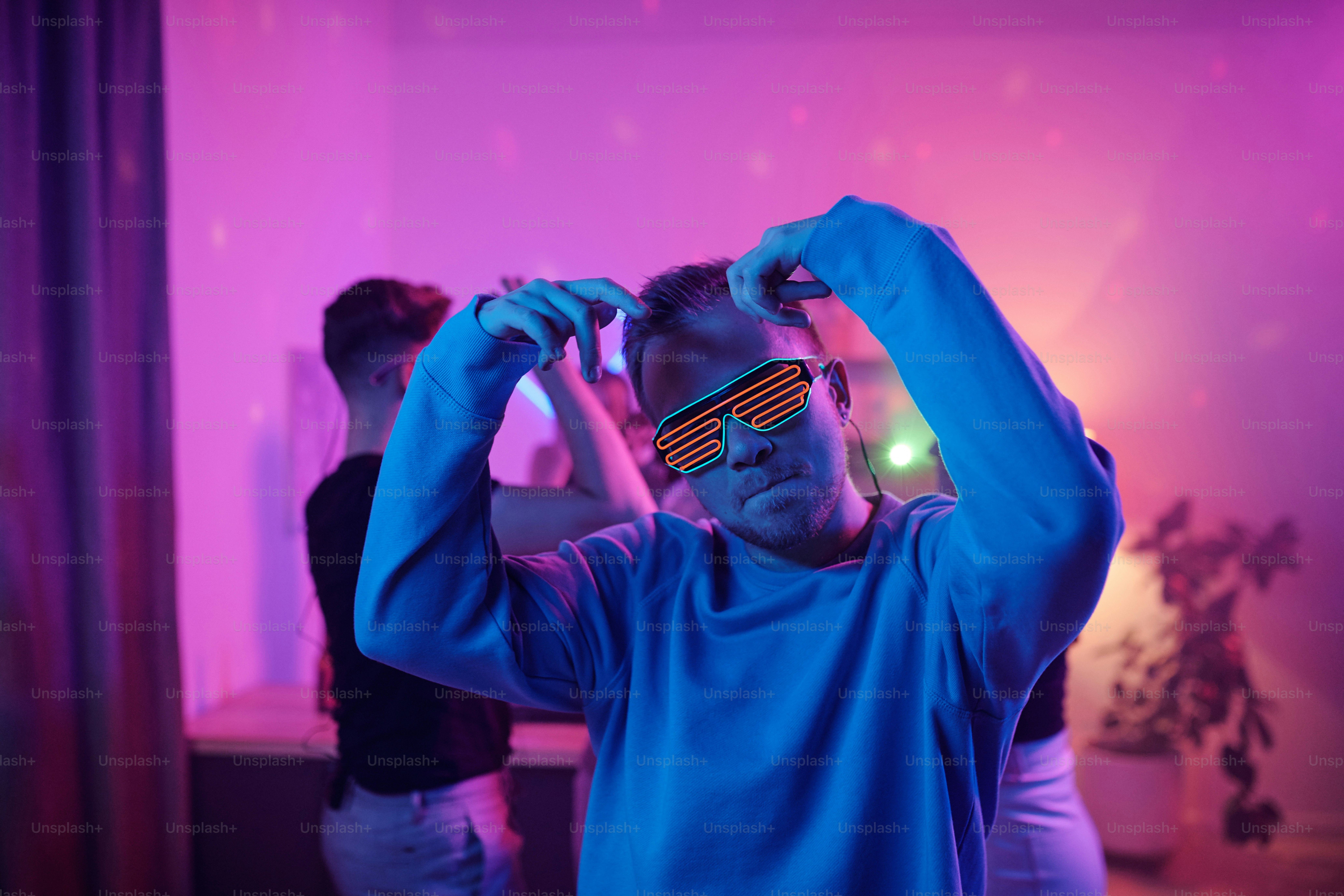 Young serious man in casualwear and disco eyeglasses looking at you ...