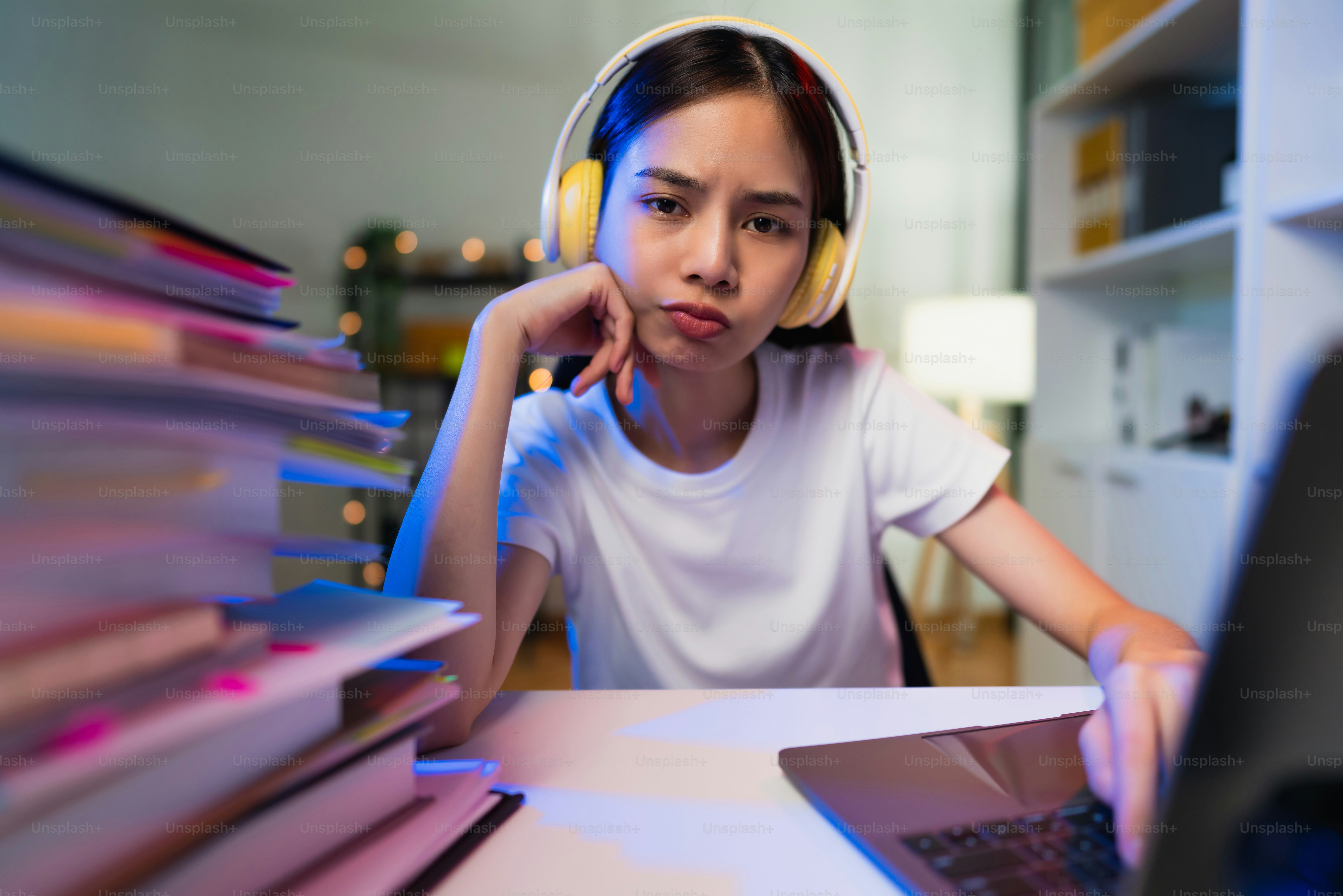 Boring young woman wearing headset and hand typing on keyboard with ...