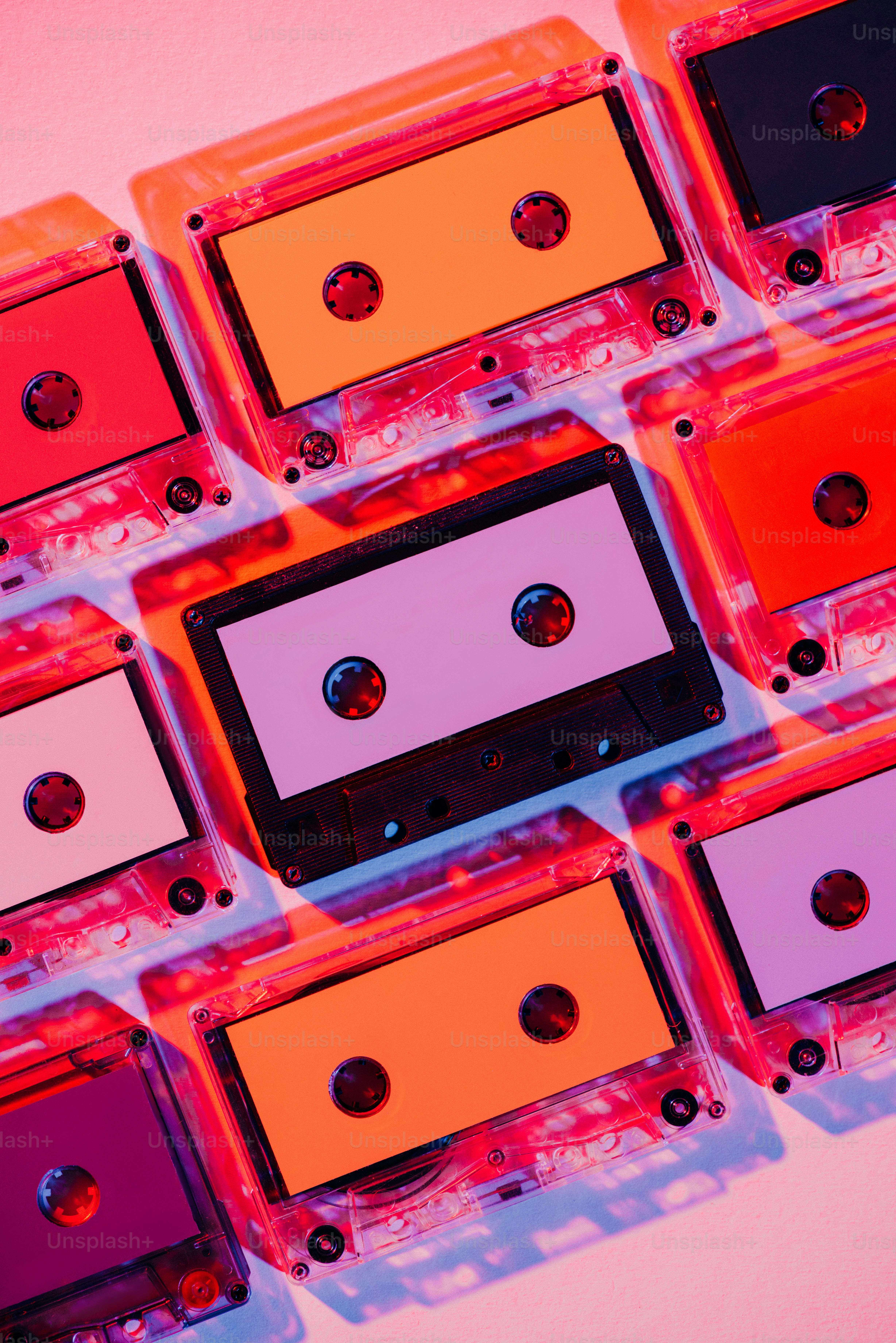 Toned picture of colorful retro audio cassettes on pink background ...