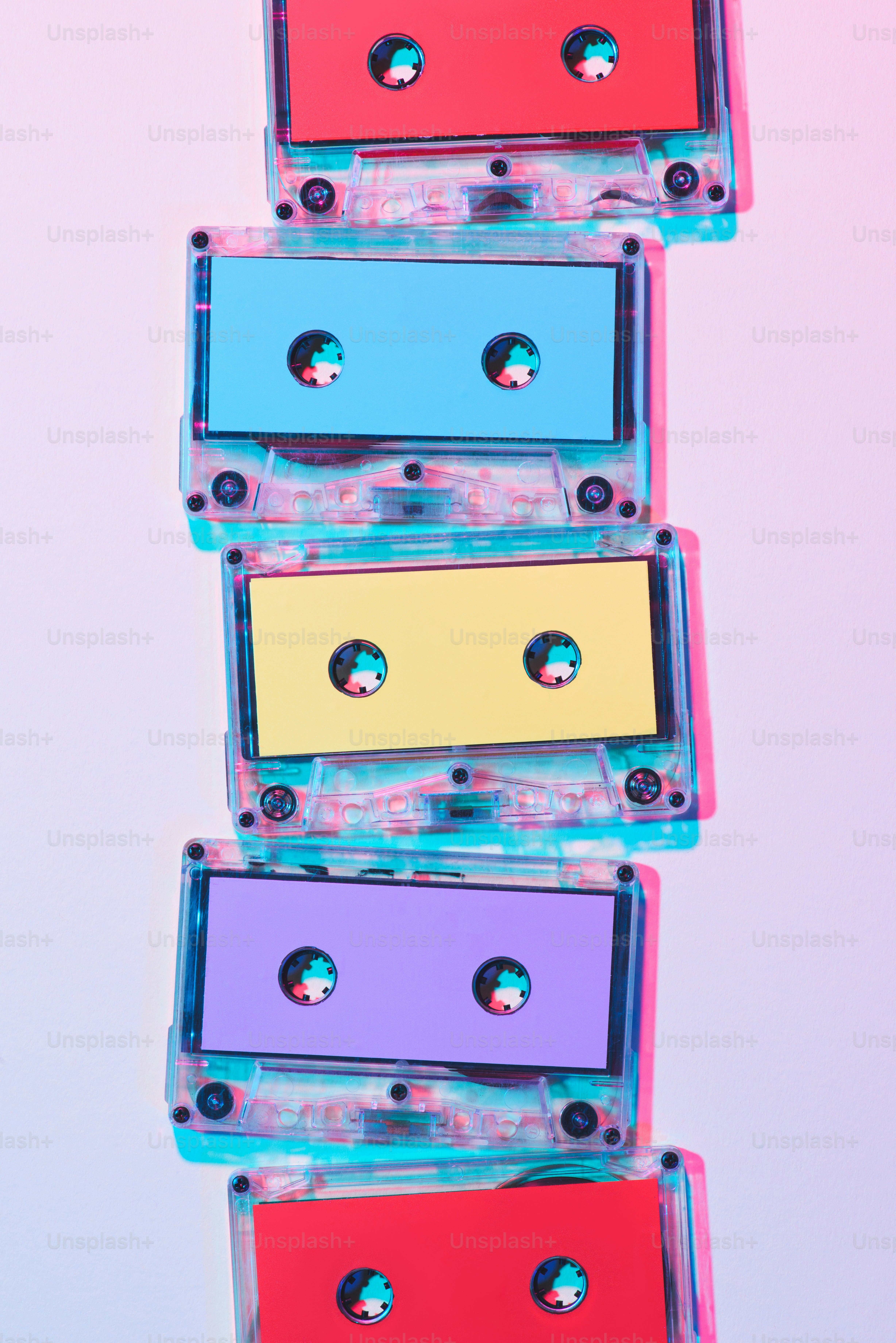Top view of arranged colorful audio cassettes on purple background ...