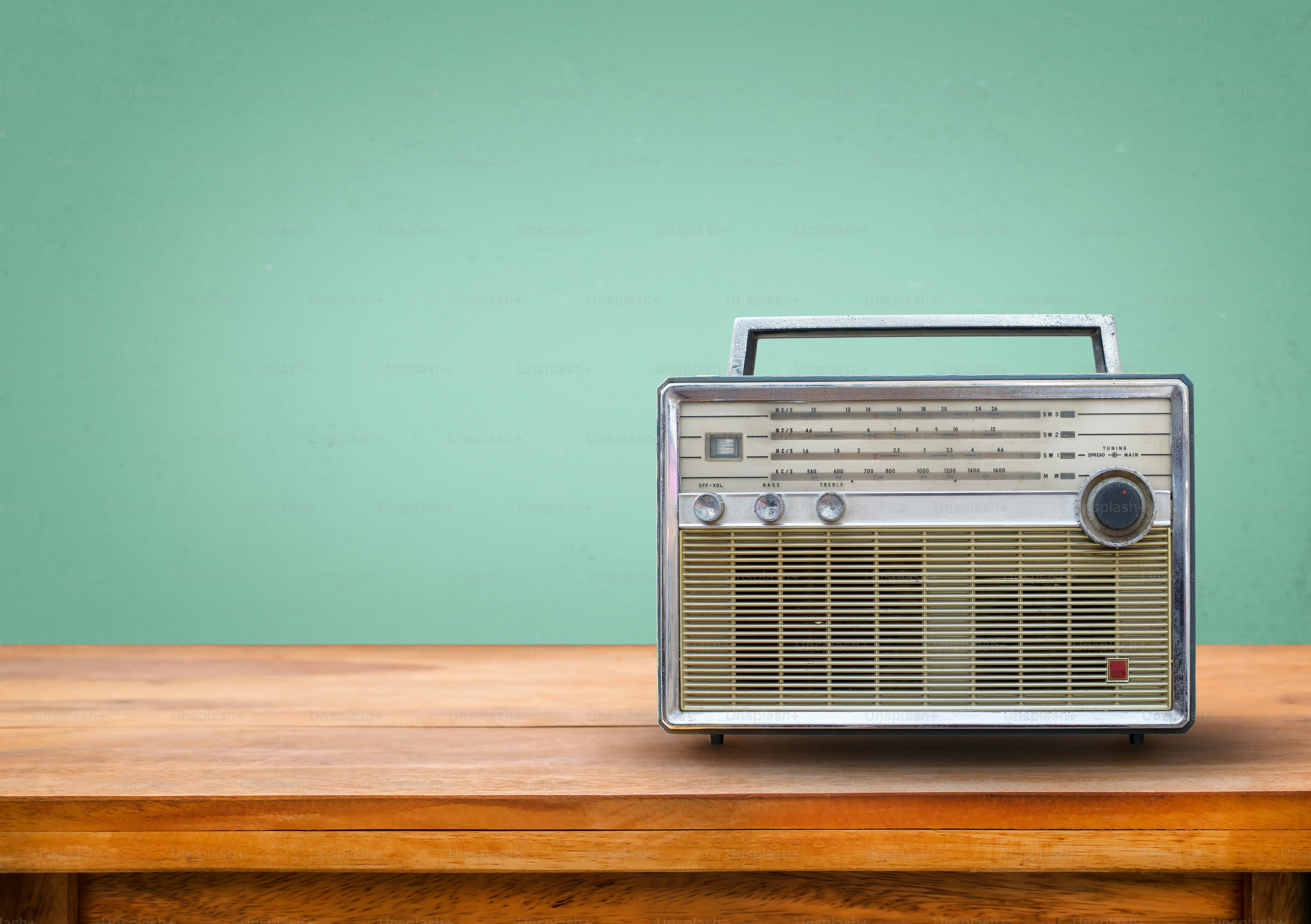 Old retro radio on table with vintage green eye light background photo ...