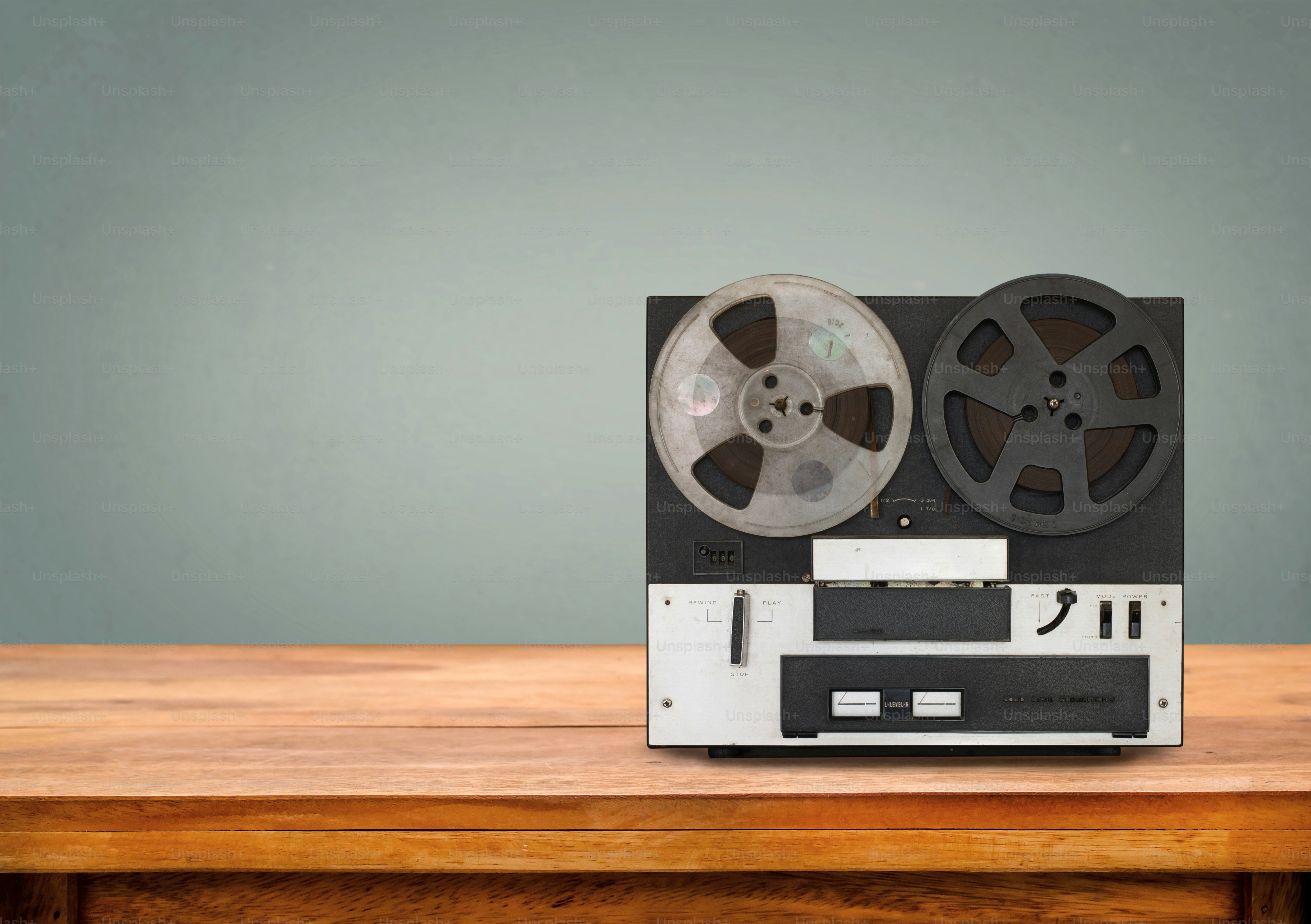 Old retro movie player on table with vintage gray gradient background ...