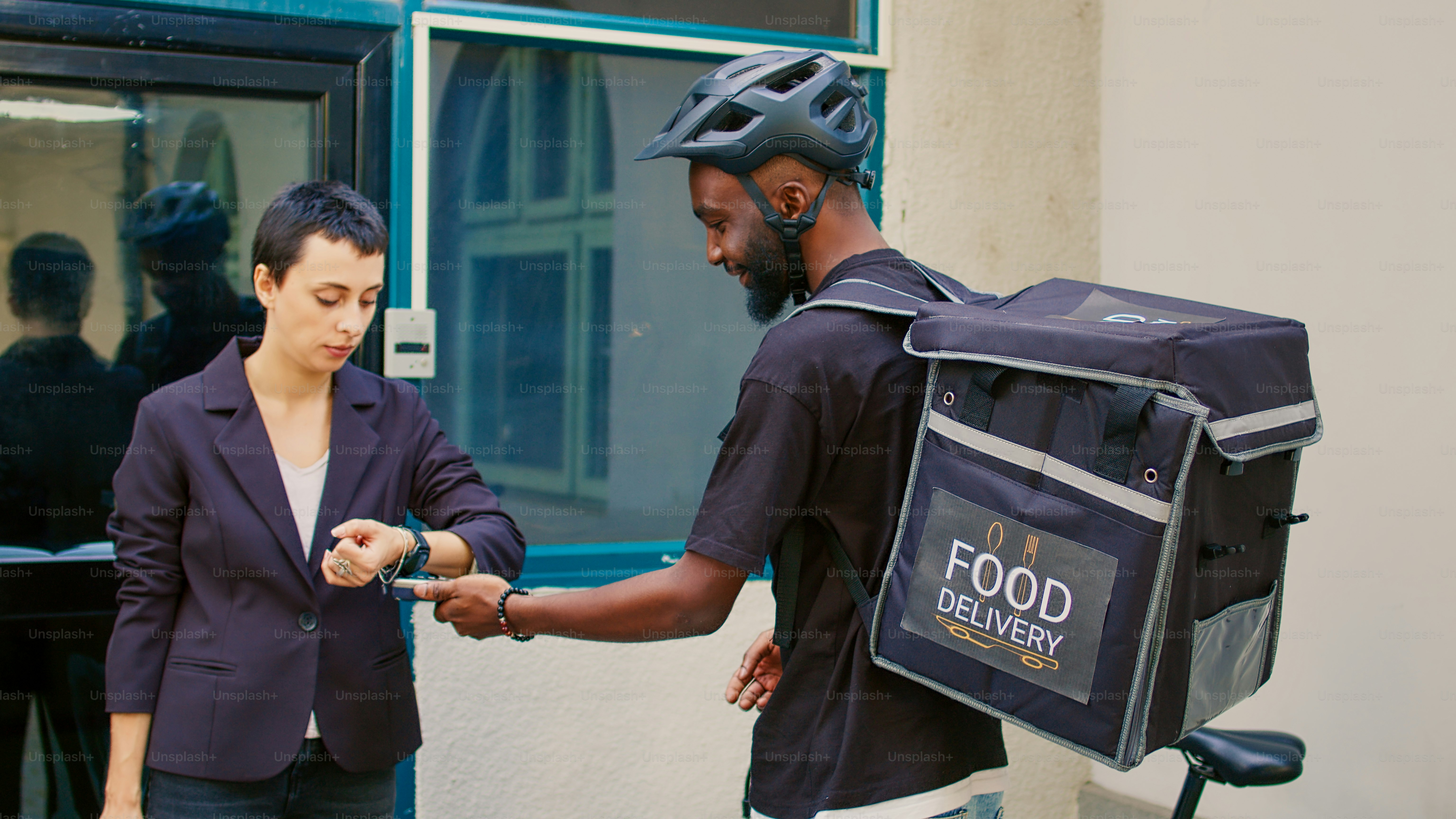 Food delivery service courier giving customer pizza order. African ...