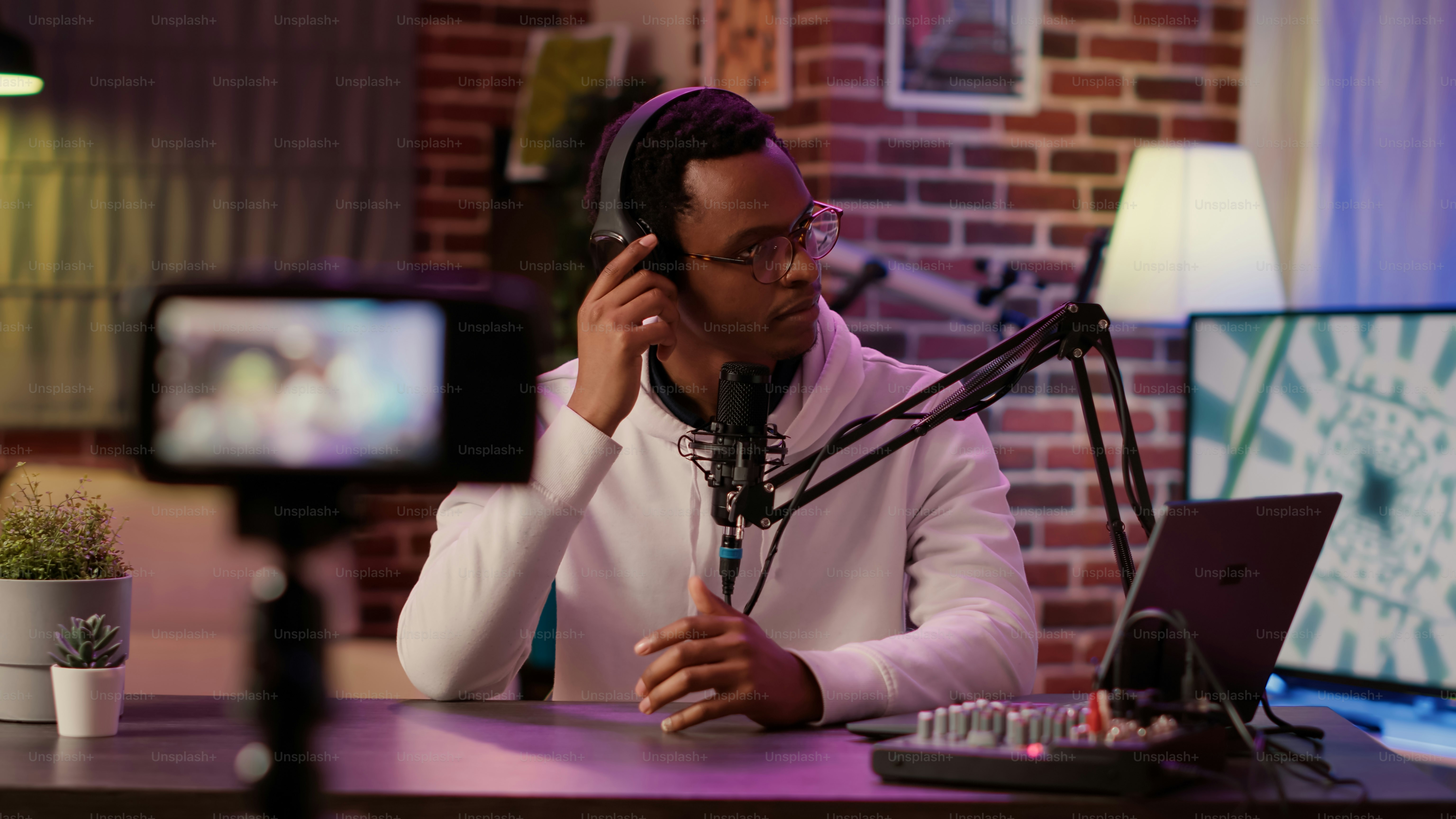 African american influencer recording podcast using digital video ...
