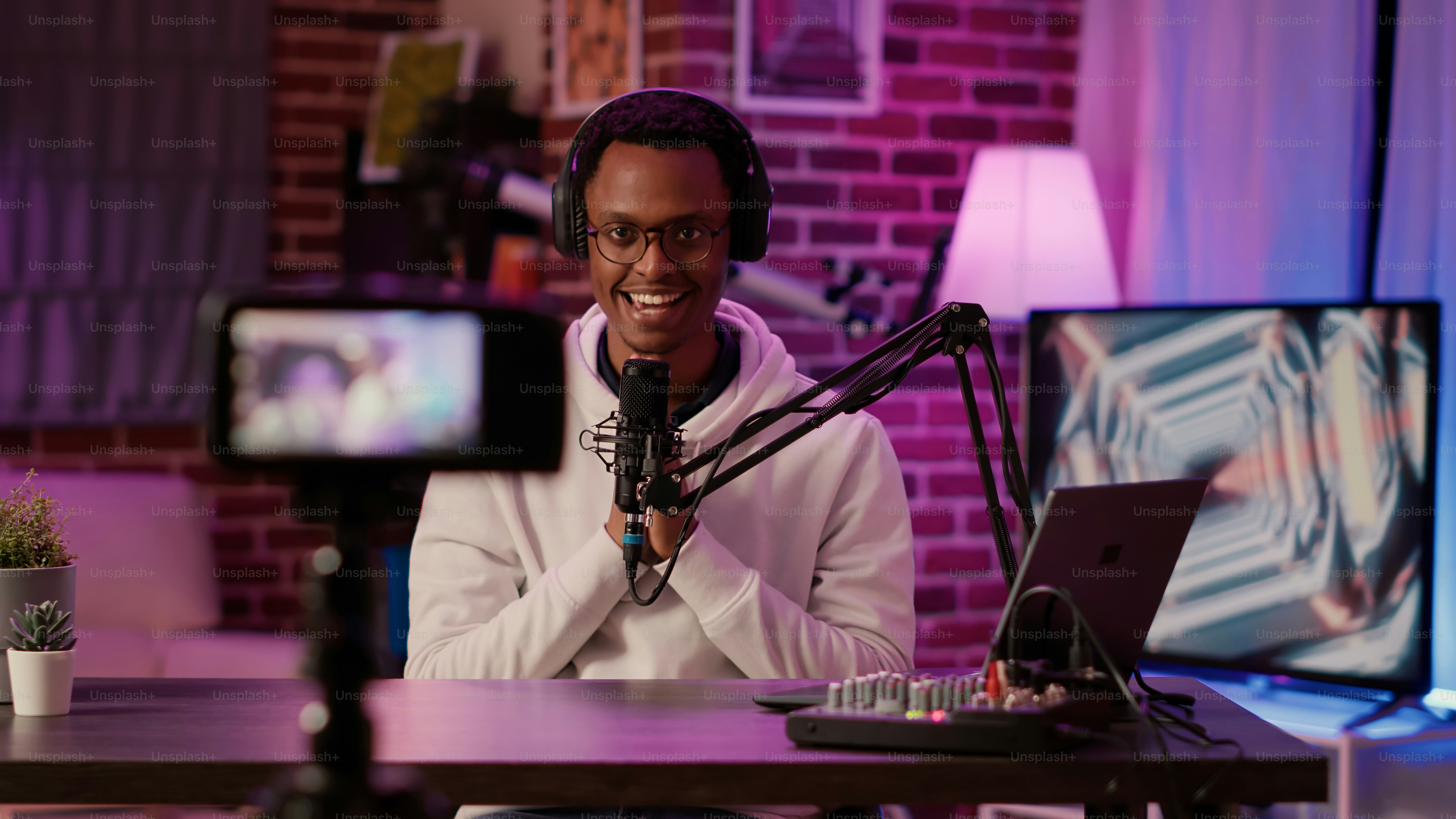 African american influencer recording podcast using digital video ...