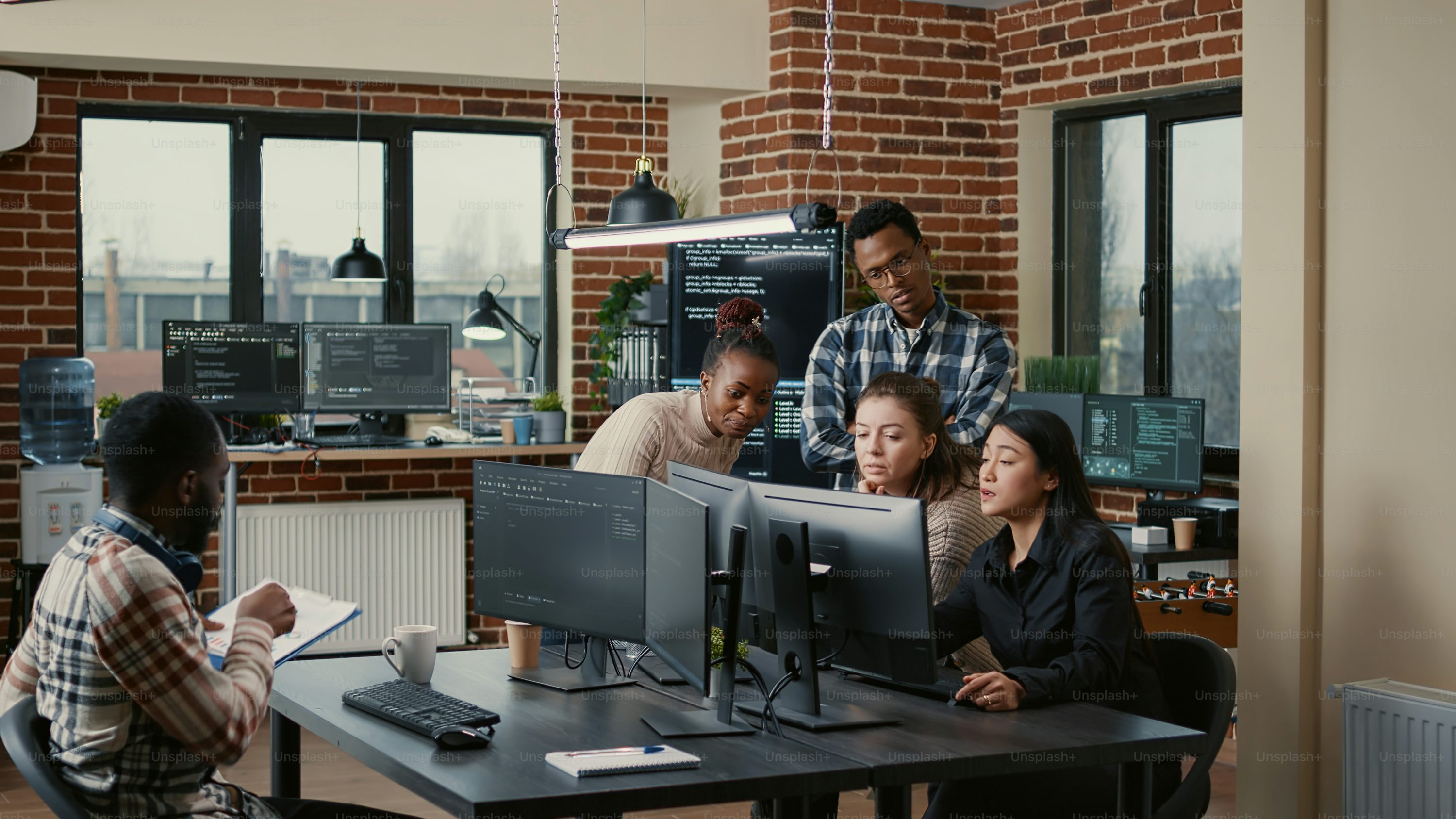 Software engineers brainstorming ideas looking at code on computer ... Software engineers brainstorming ideas looking at code on computer ...