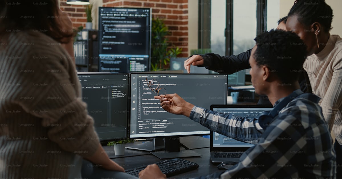 Software developers discussing about source code compiling discovers ... Software developers discussing about source code compiling discovers ...