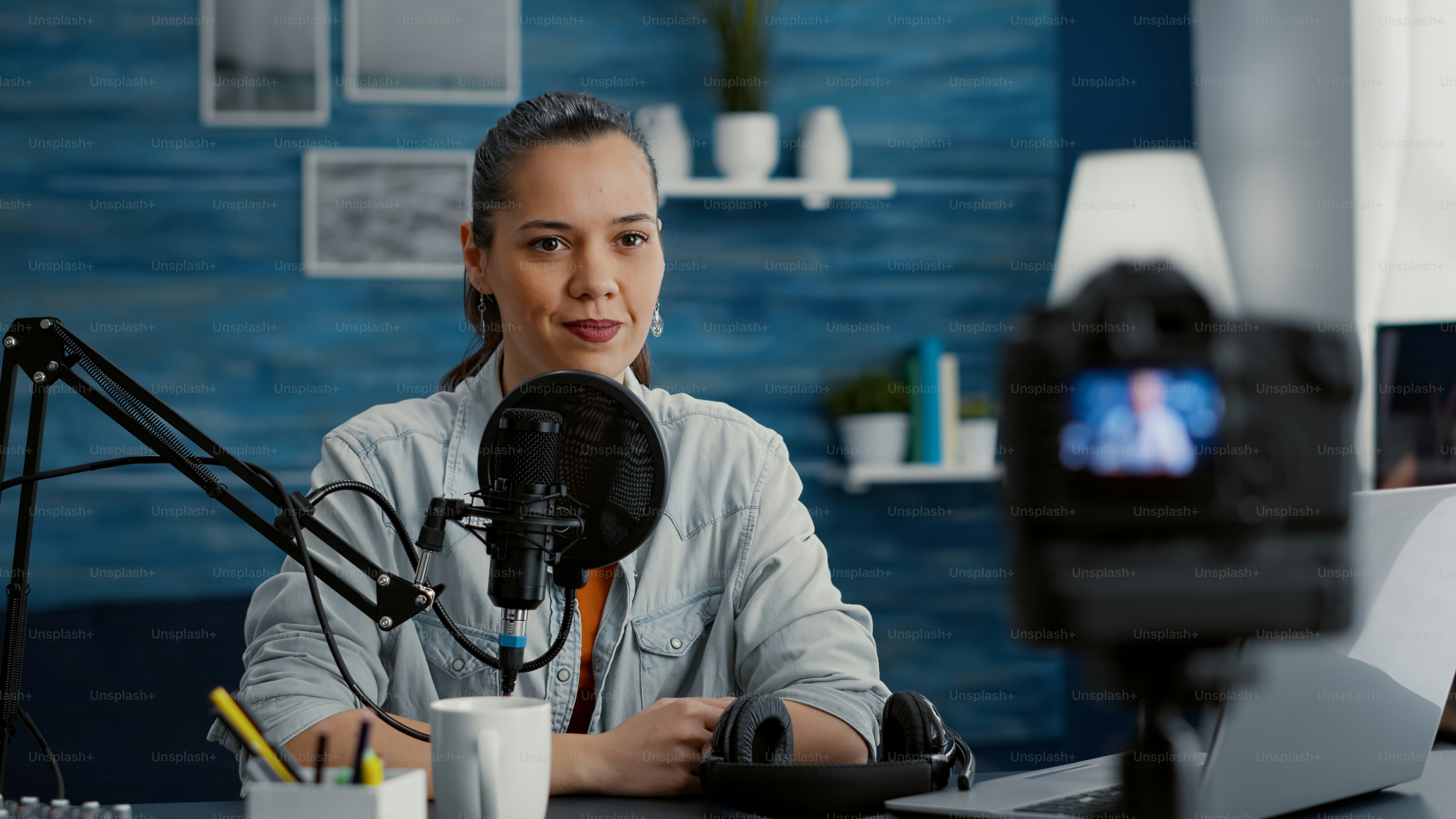Popular social media influencer sitting at home studio desk while ...