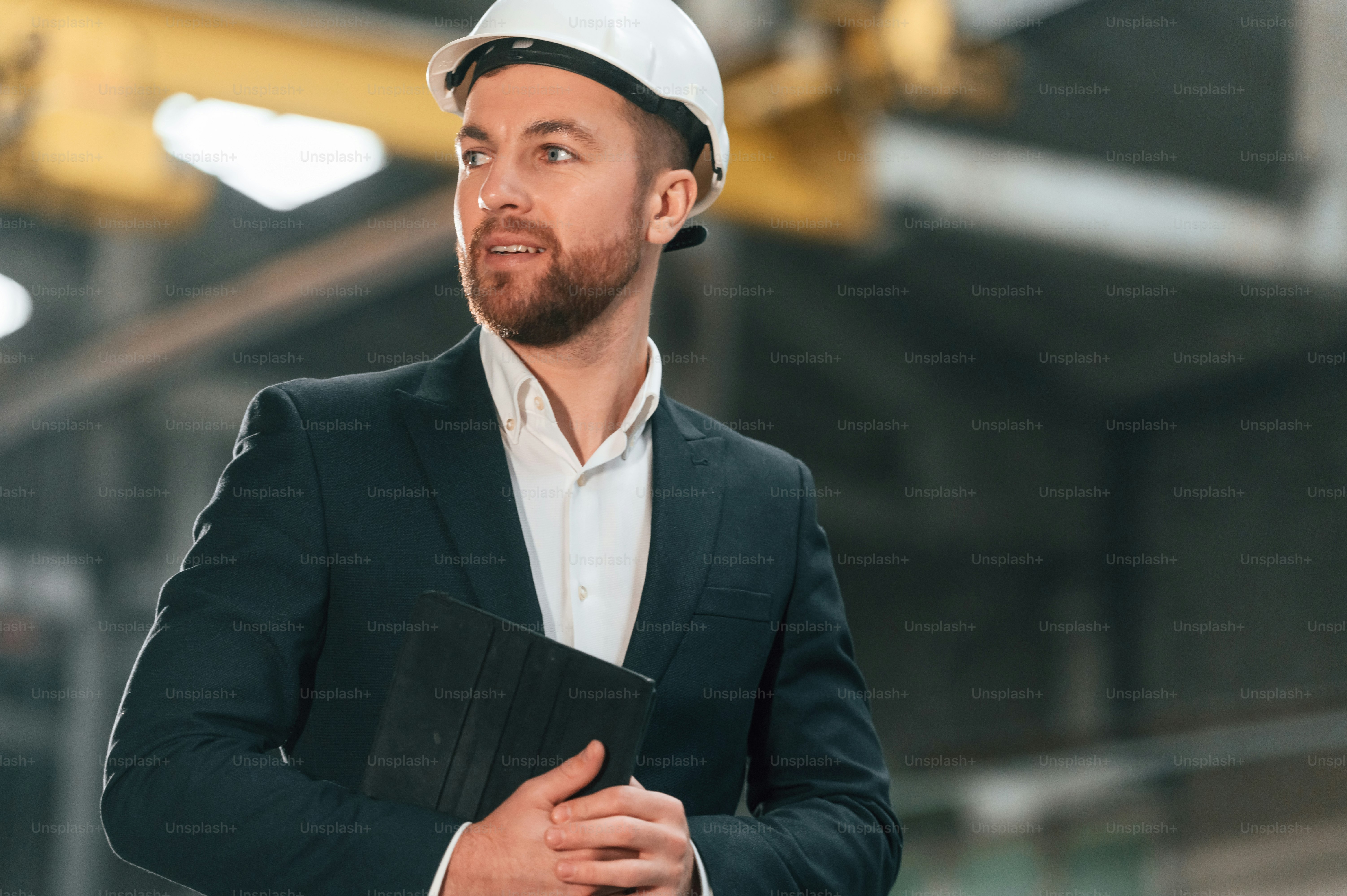 Portrait of manager that is in black formal wear at the factory. photo ...