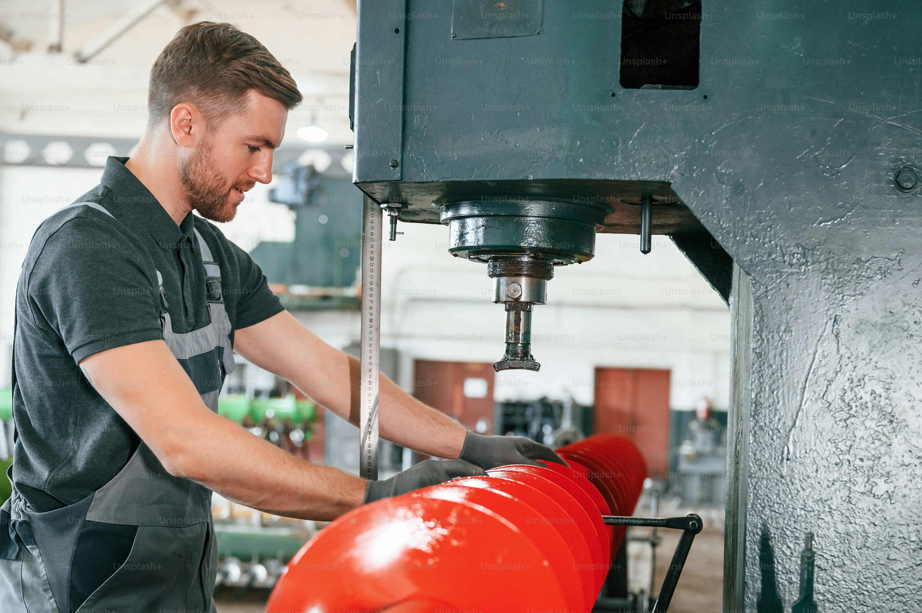 Metal processing device. Man in uniform is in workstation developing ... Metal processing device. Man in uniform is in workstation developing ...