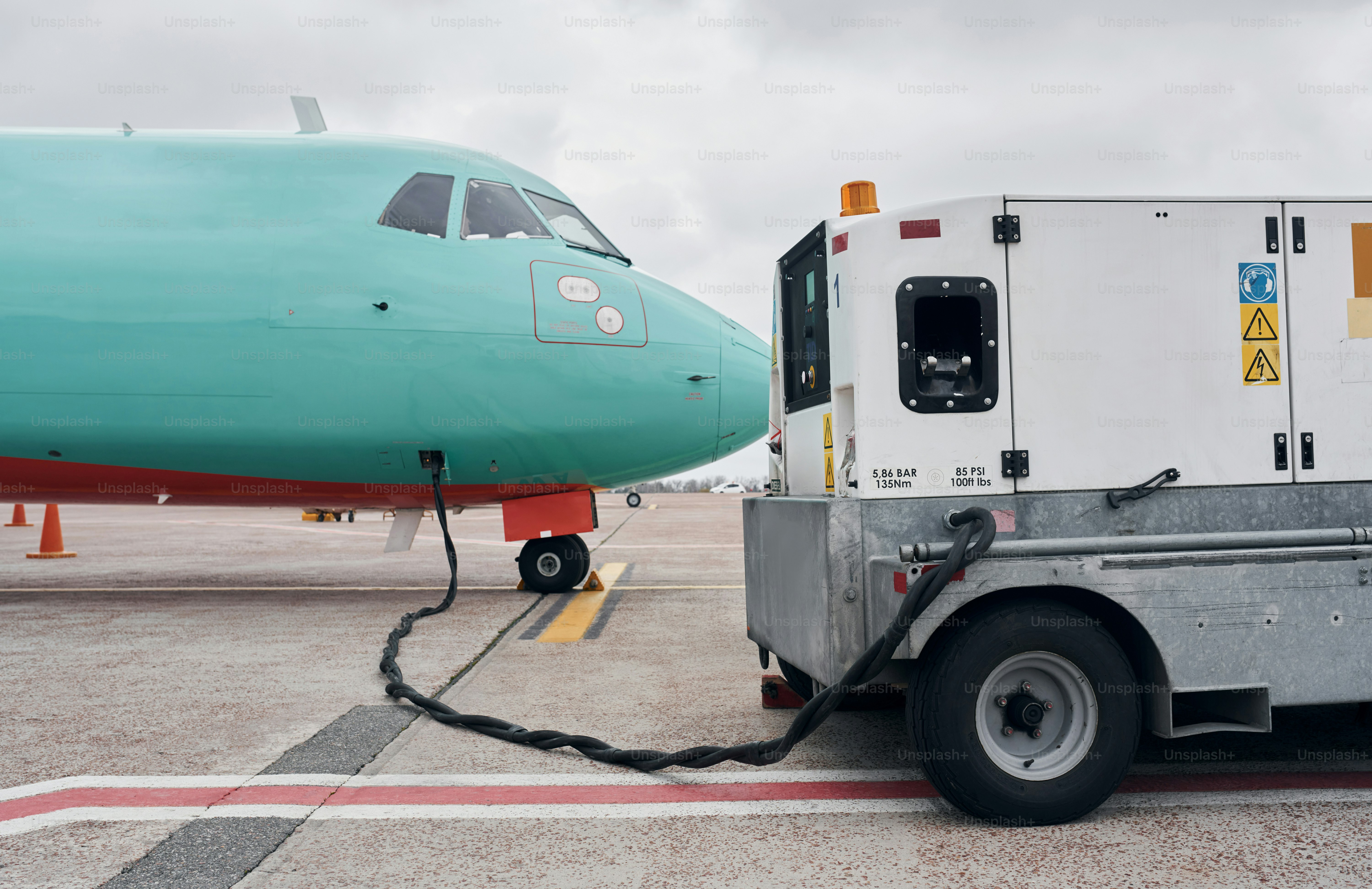 Front view. Turboprop aircraft parked on the runway at daytime. photo ...