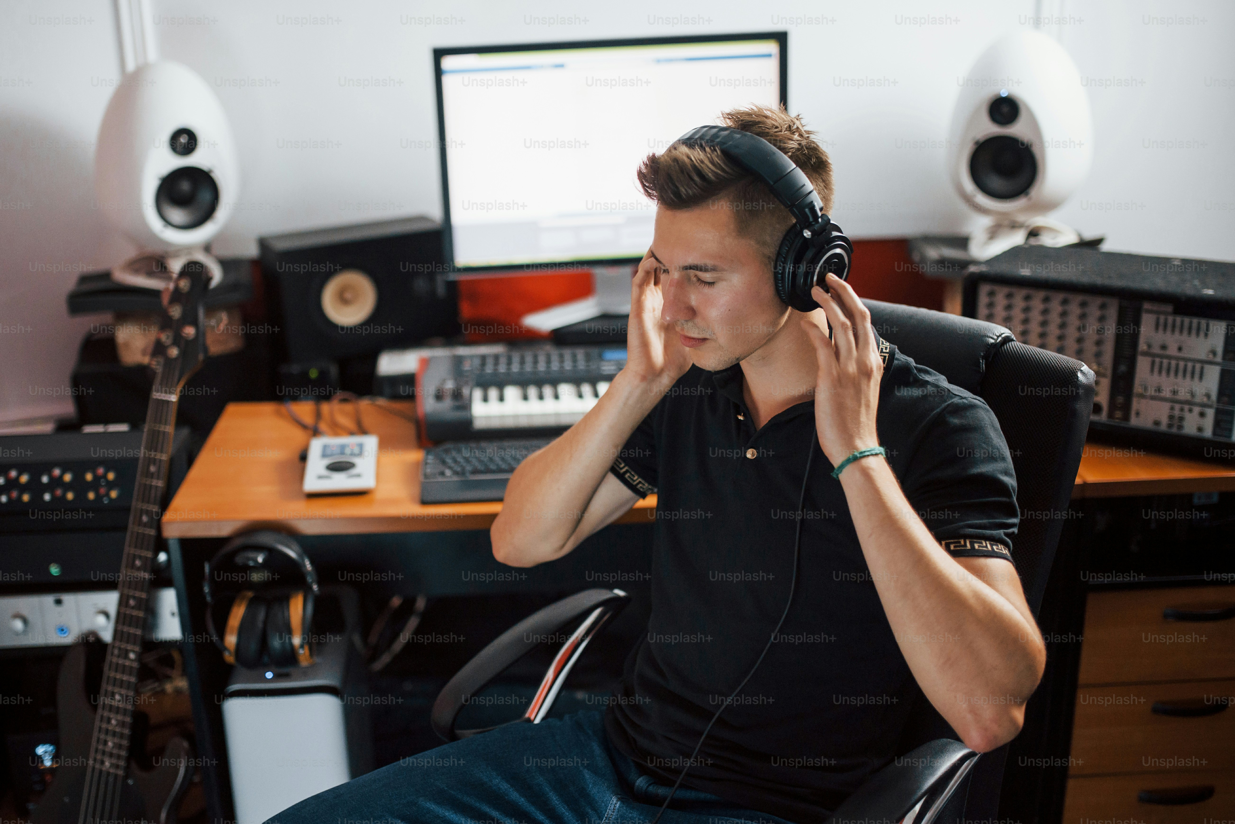 Satisfied with audio quality. Sound engineer in headphones working and ...