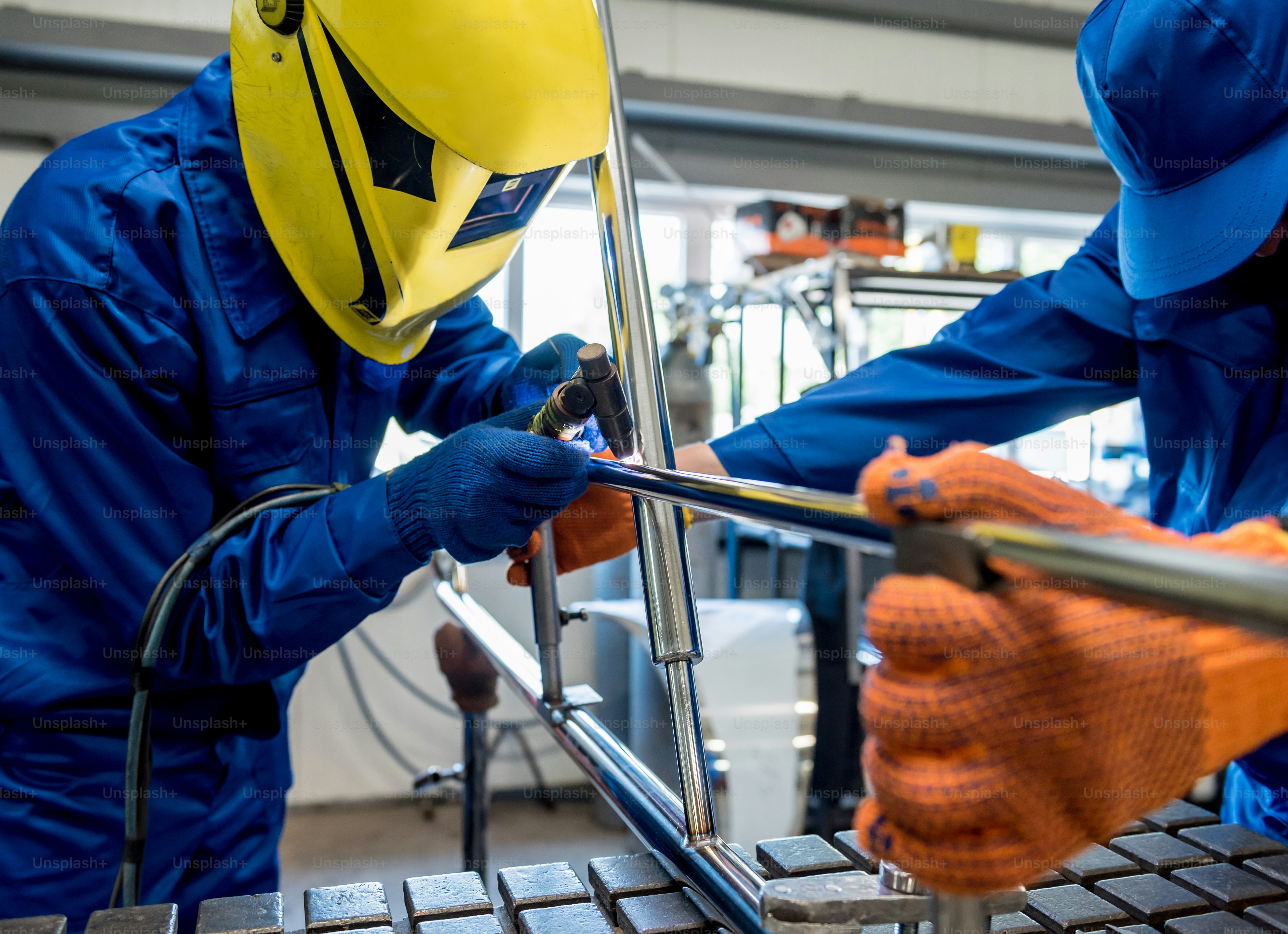 Welder working in a steel factory with argon welding. photo – Welding ...