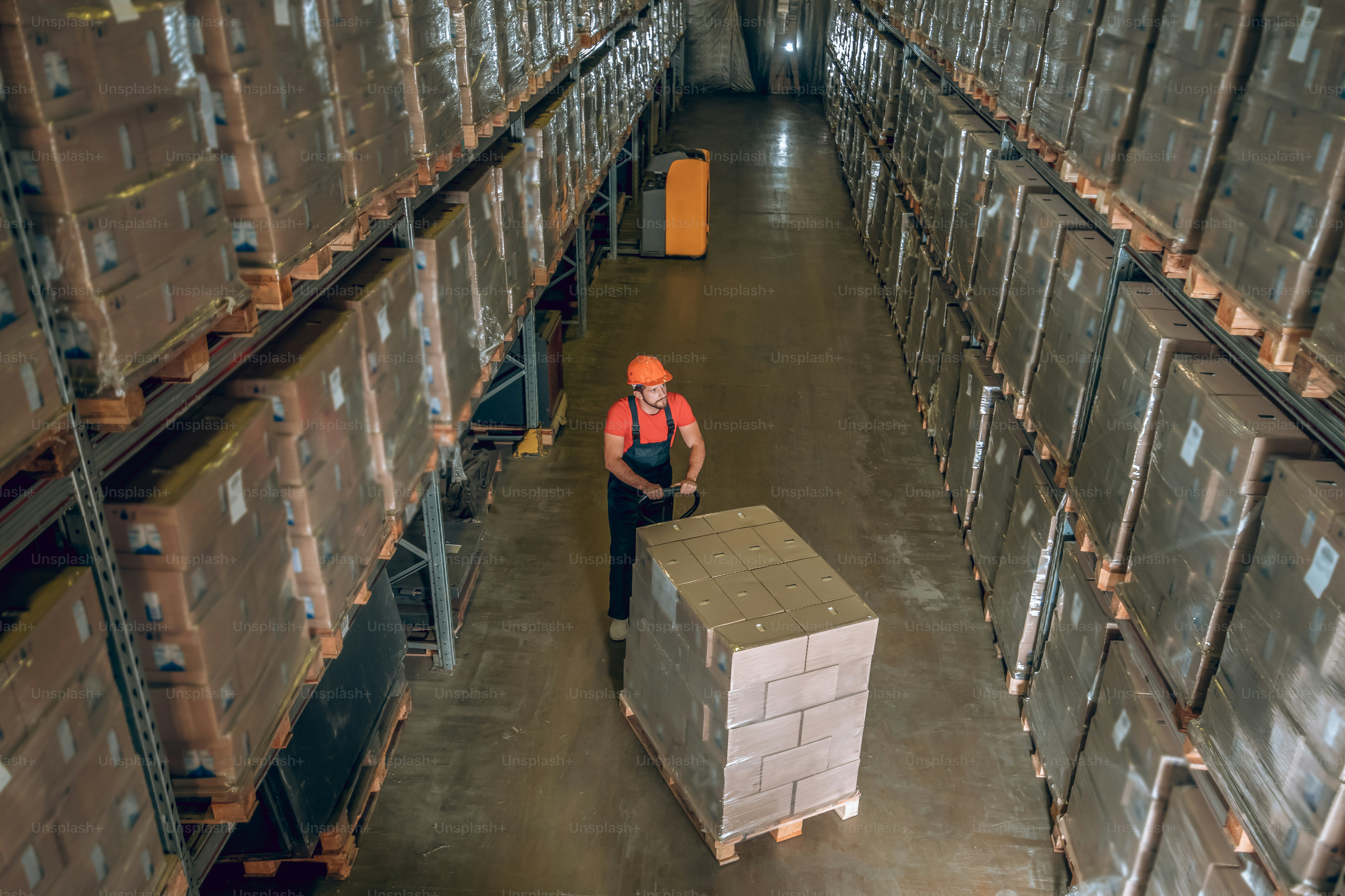 Work in warehouse. View of a person in megastore with lots of ...