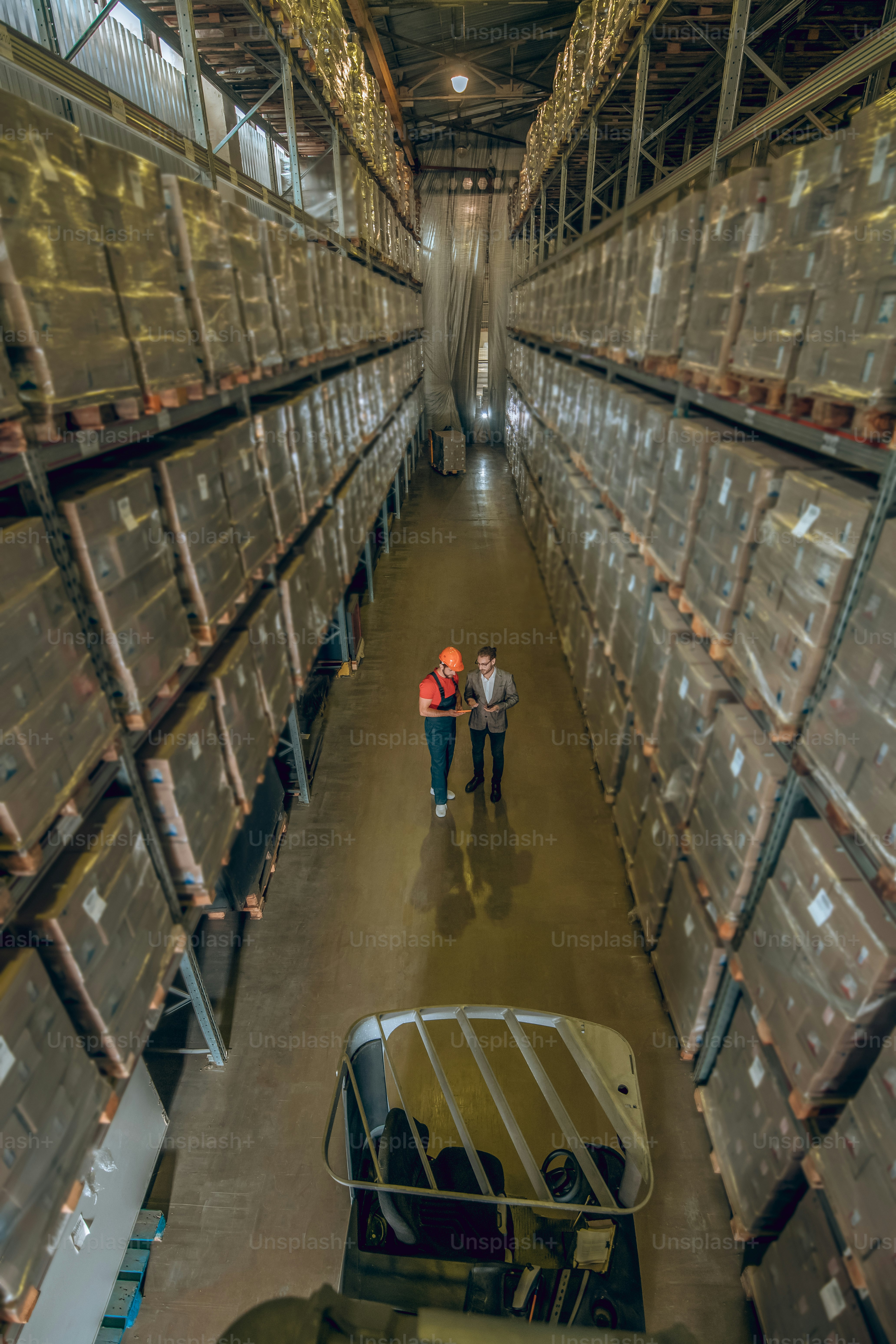 Storage compartment. Two people in megastore with lots of containers on ...