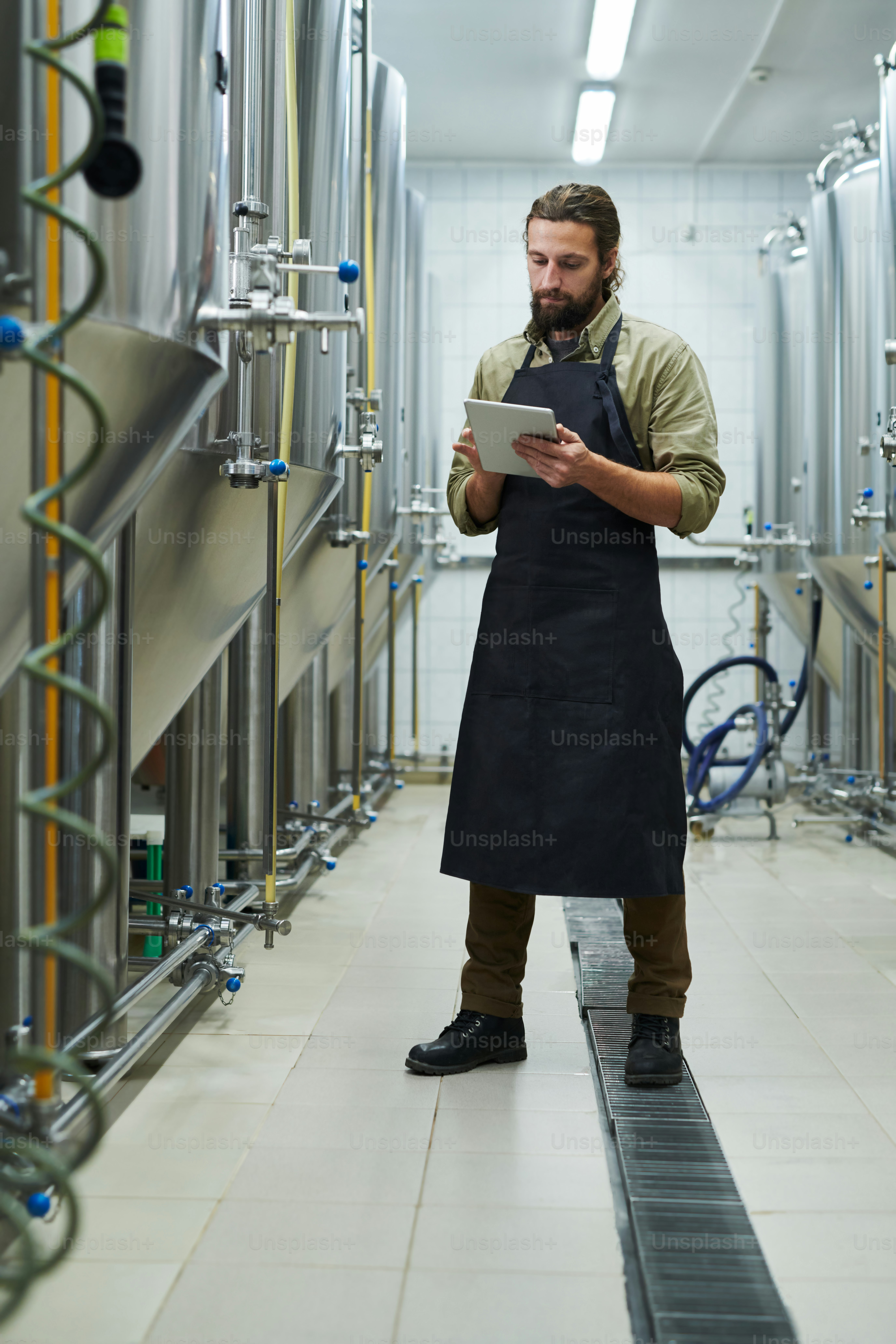 Beer brewery owner controlling production process via application on ...