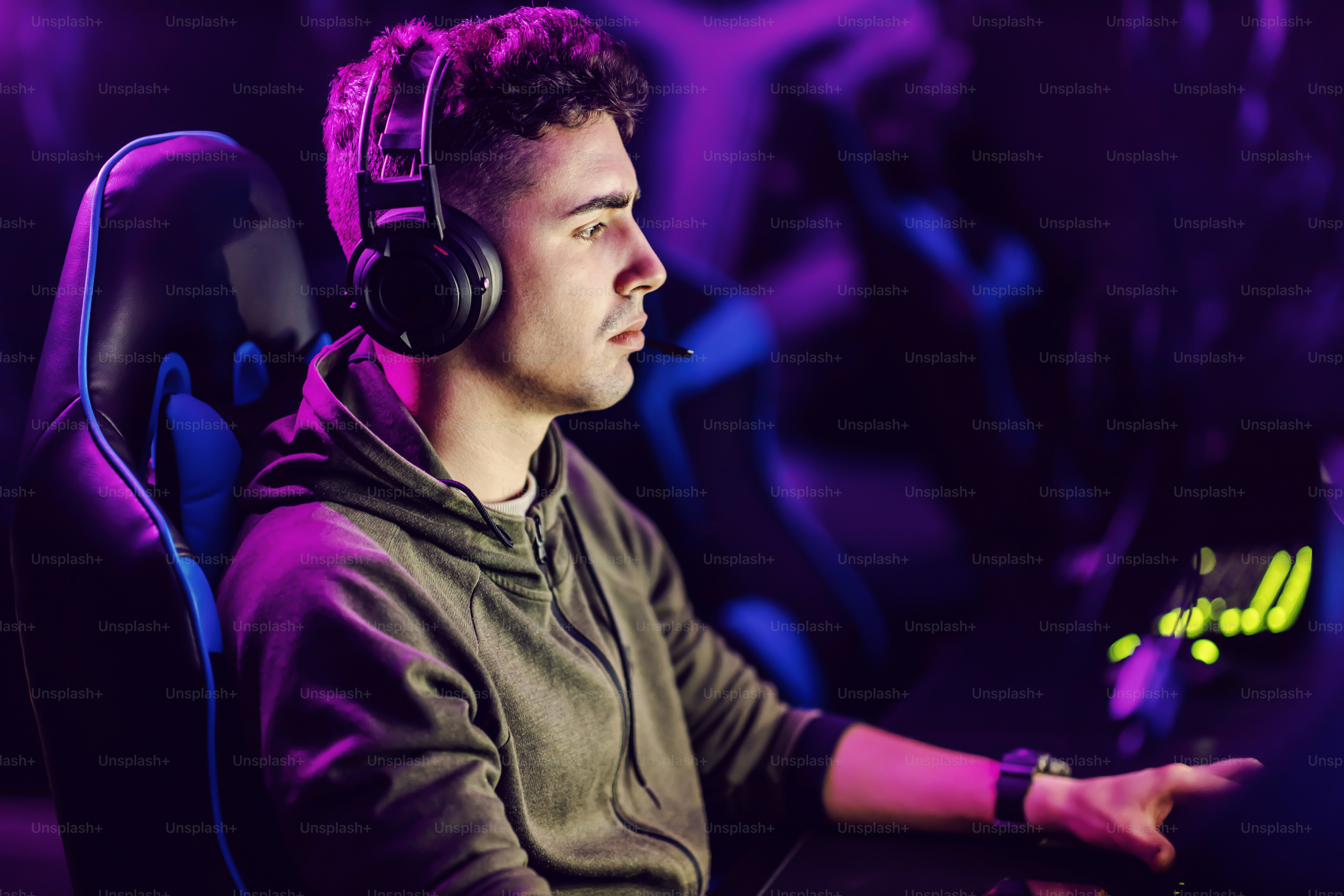 A professional gamer playing video game at gaming room. photo – Gamer ...