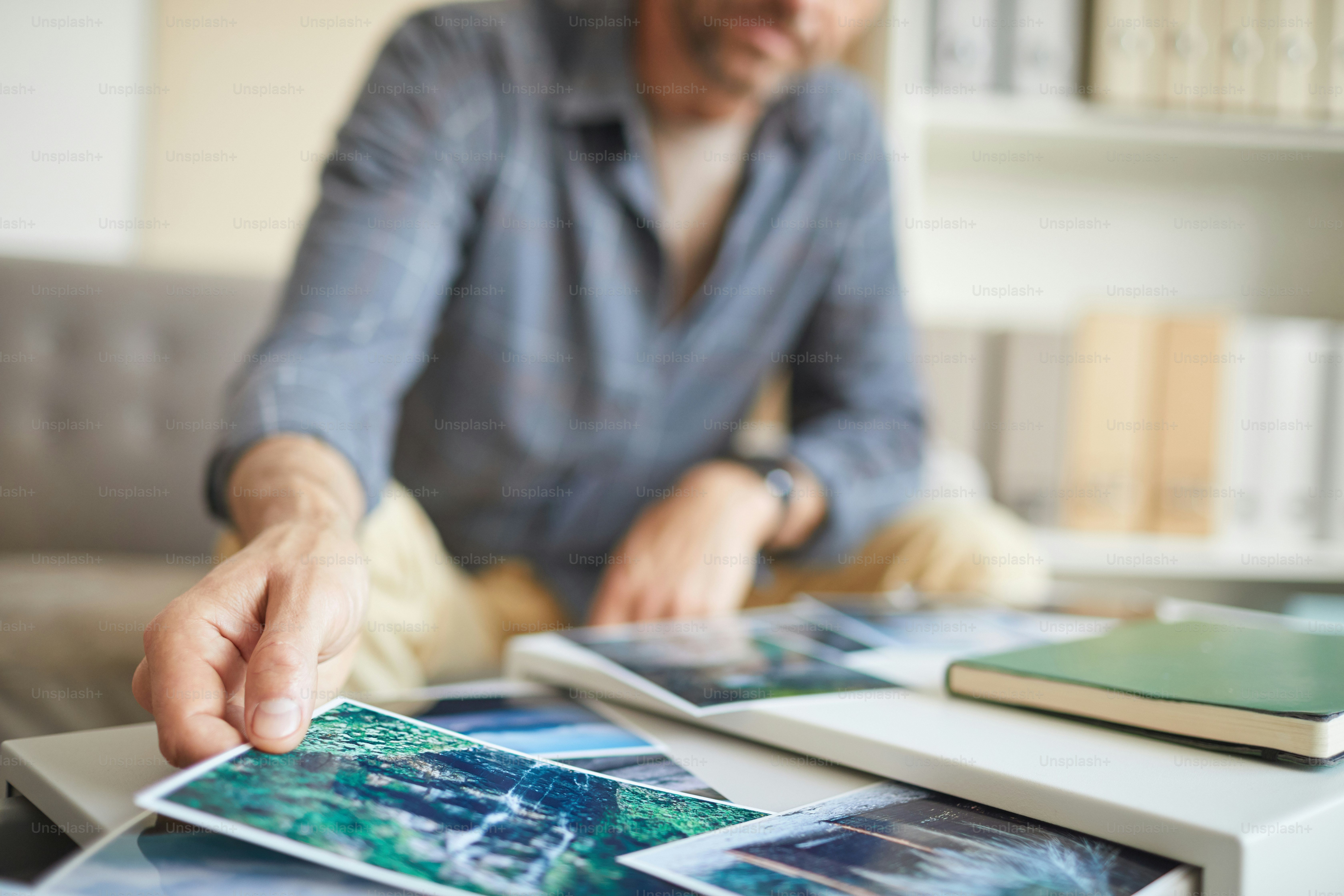 Close-up of designer choosing the best photos for art gallery photo ...