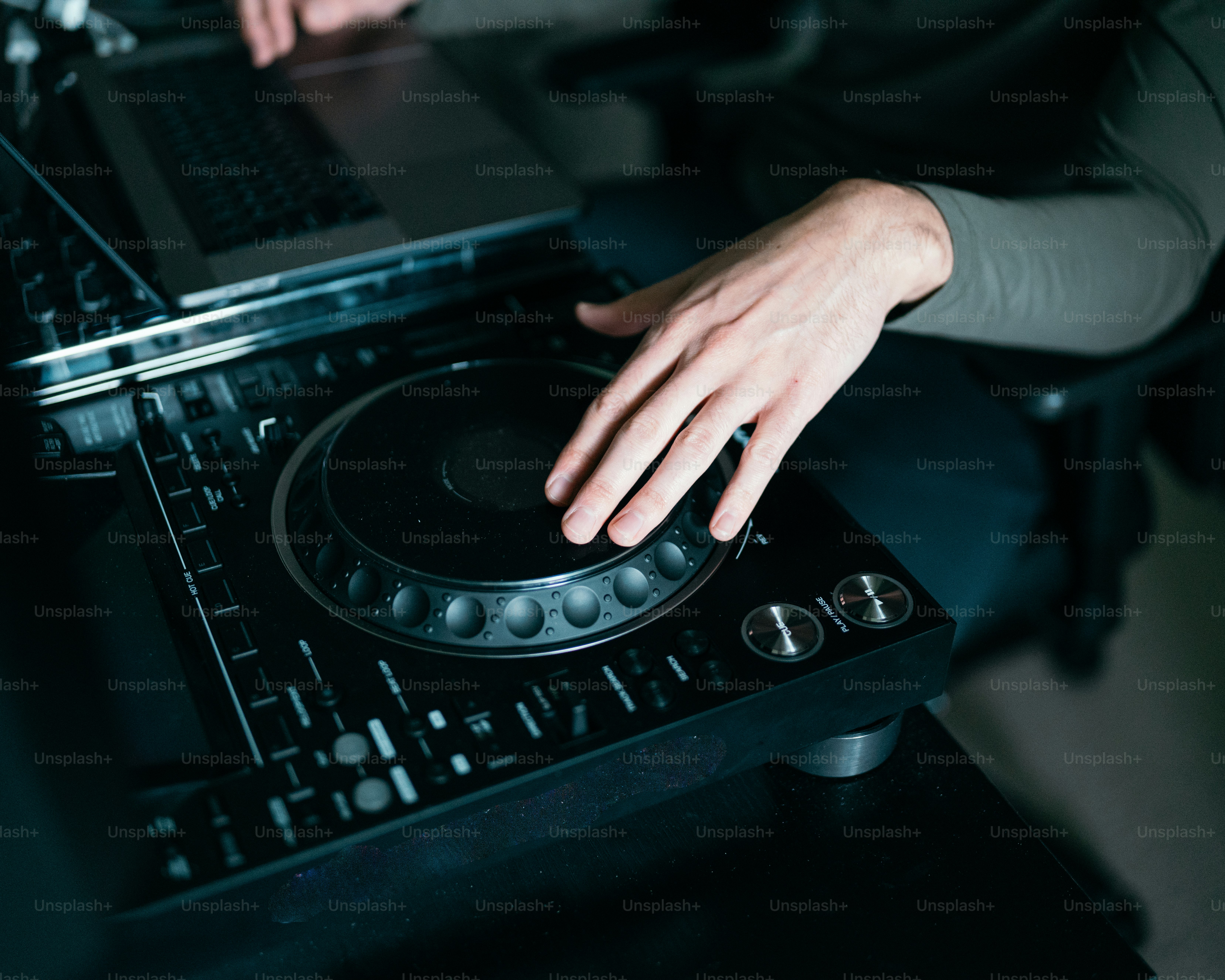 A person using a laptop on top of a dj's turntable photo – Music Image ...