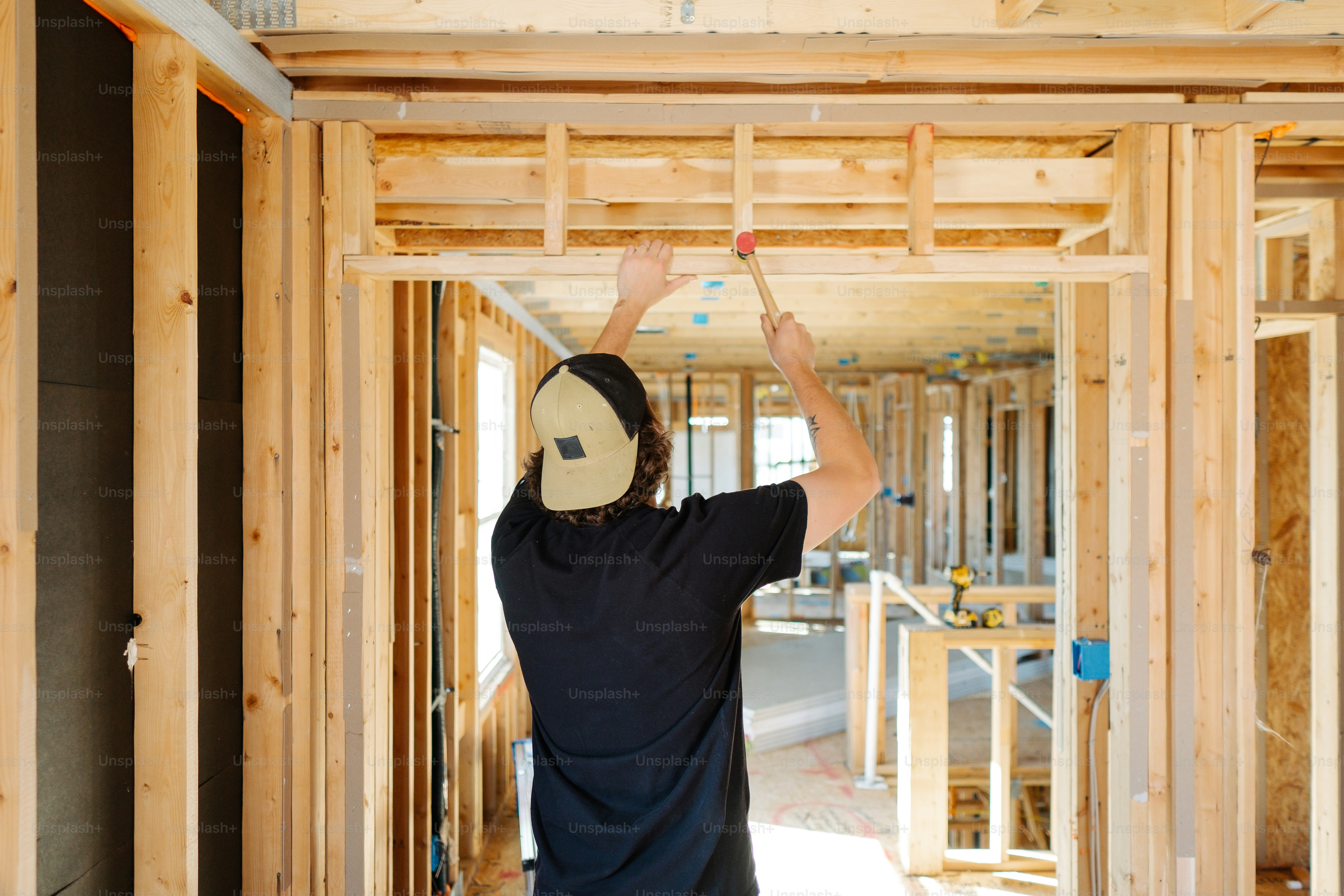A man working on a house under construction photo – Construction Image ...
