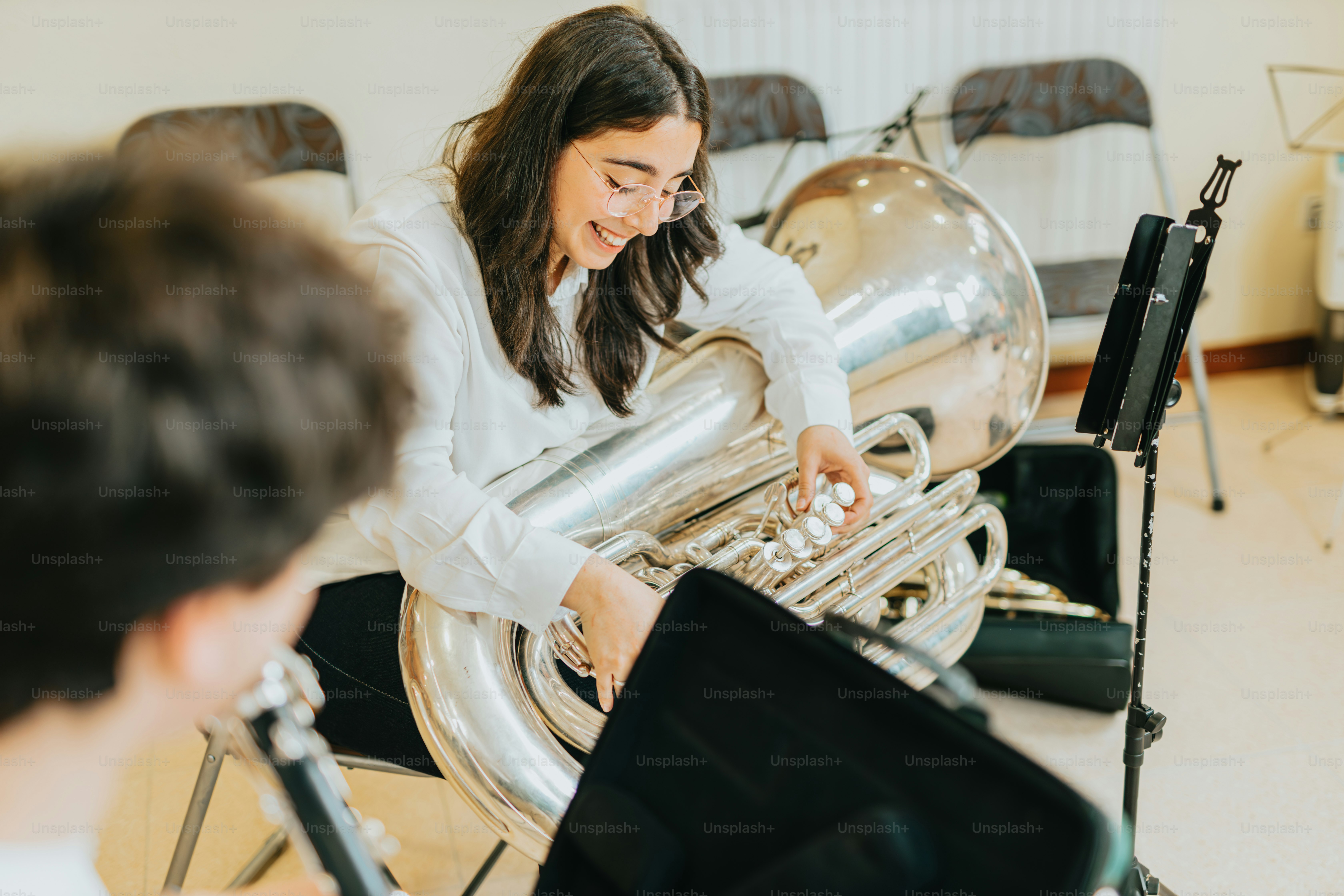 A man and a woman playing musical instruments photo – Practising Image ...