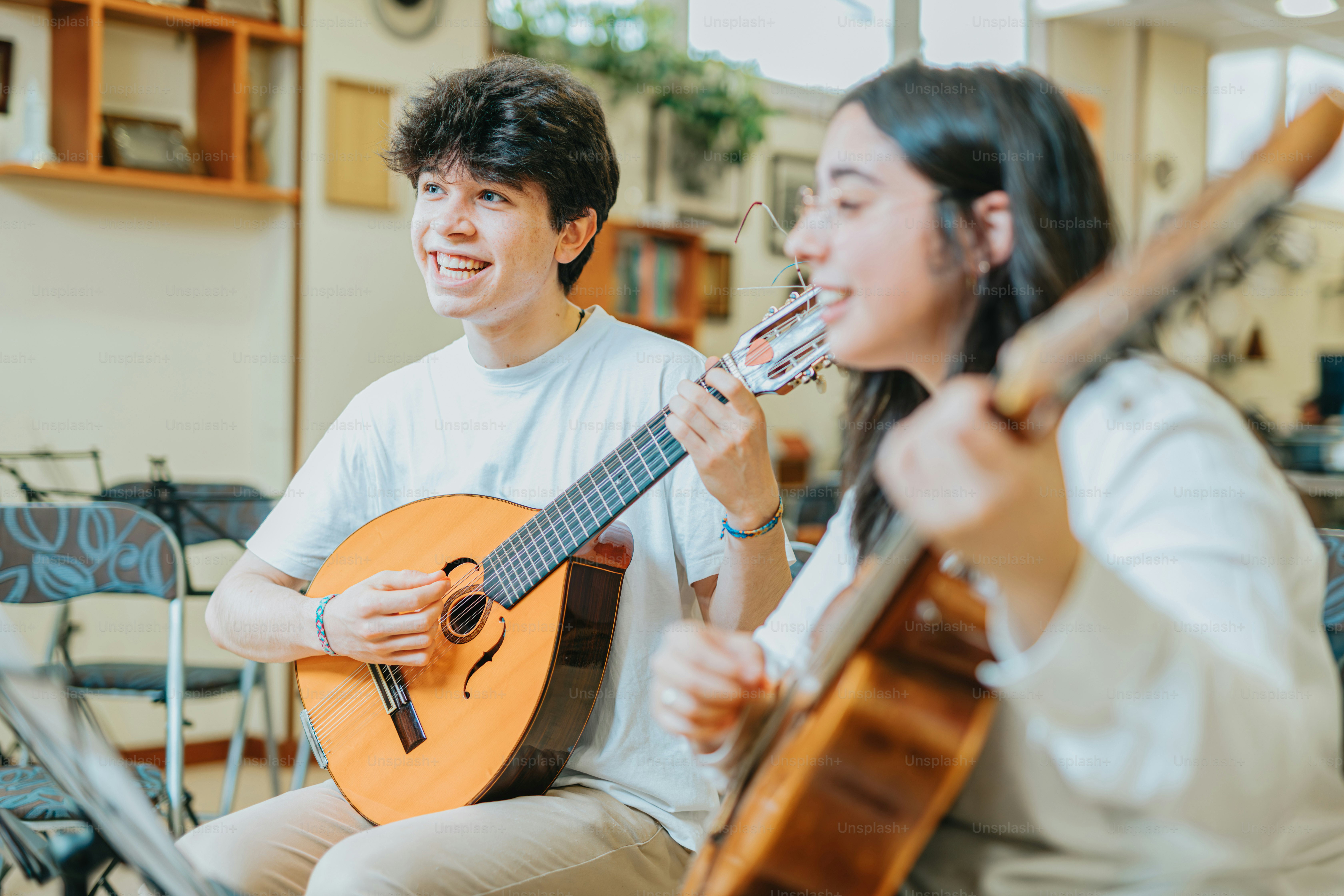 A man and a woman playing musical instruments photo – Practising Image ...