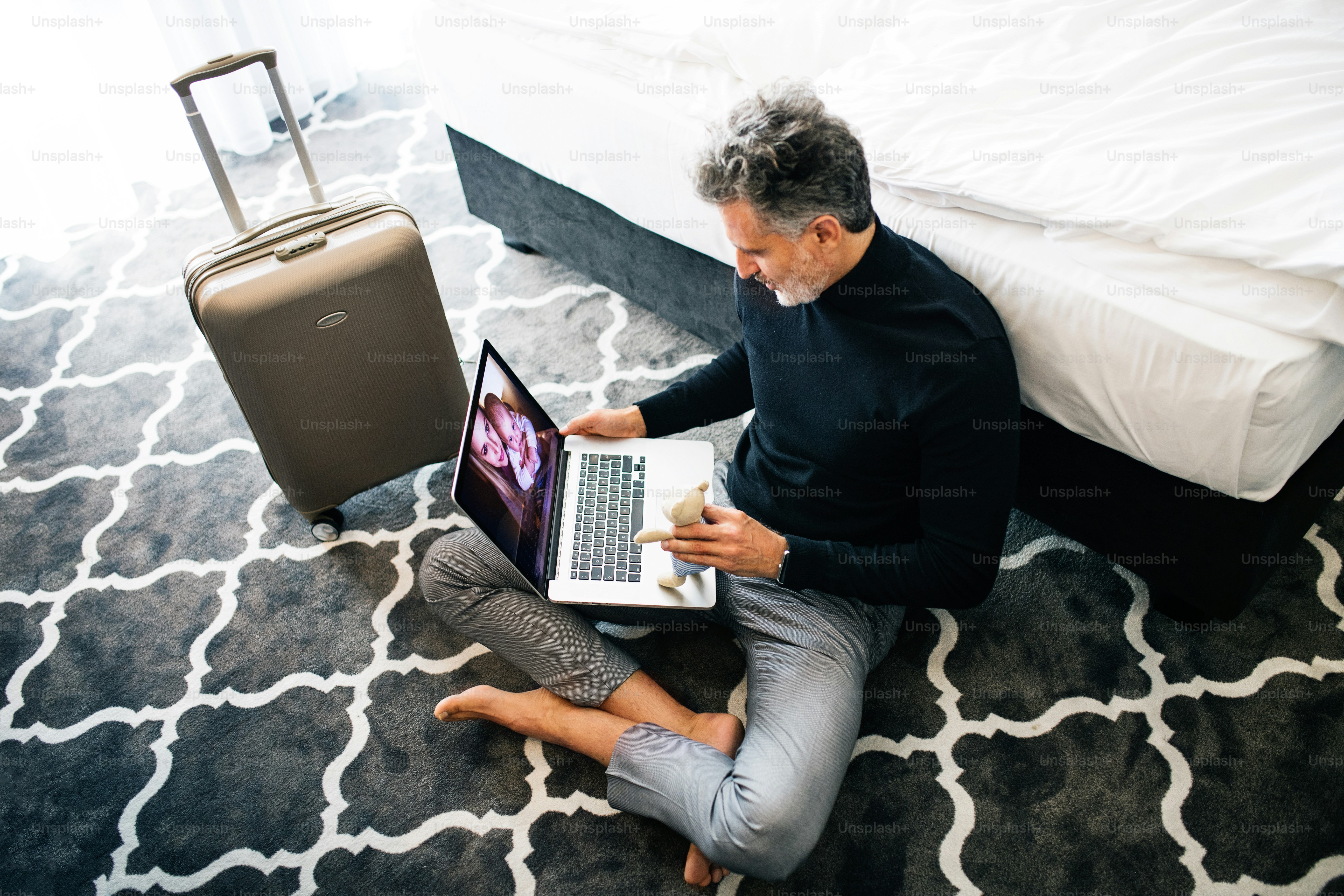 Unrecognizable businessman with laptop in a hotel room. Handsome man ...