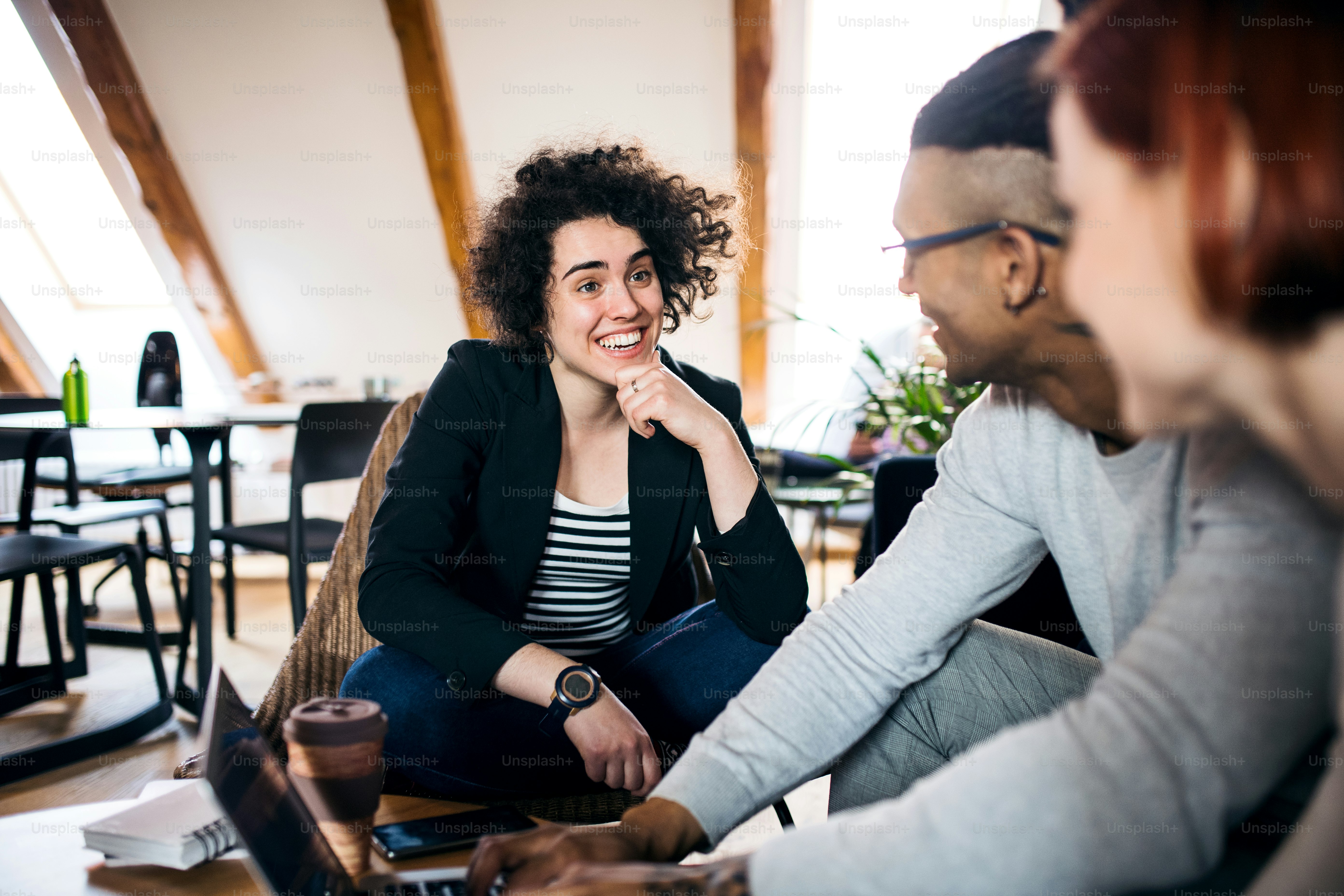 A group of young businesspeople using laptop in office, start-up ...