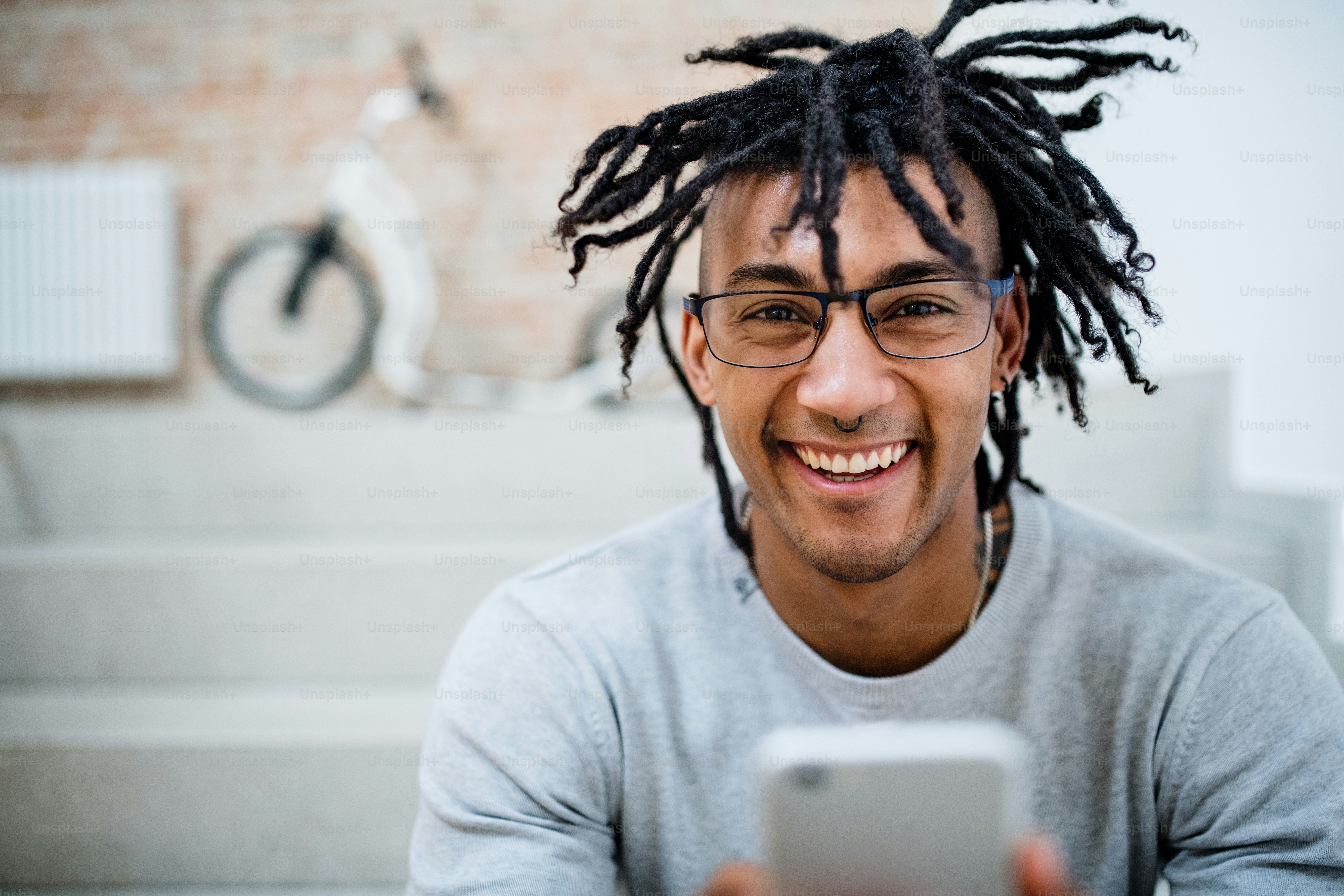 A portrait of young mixed race businessman with dreadlocks and ...